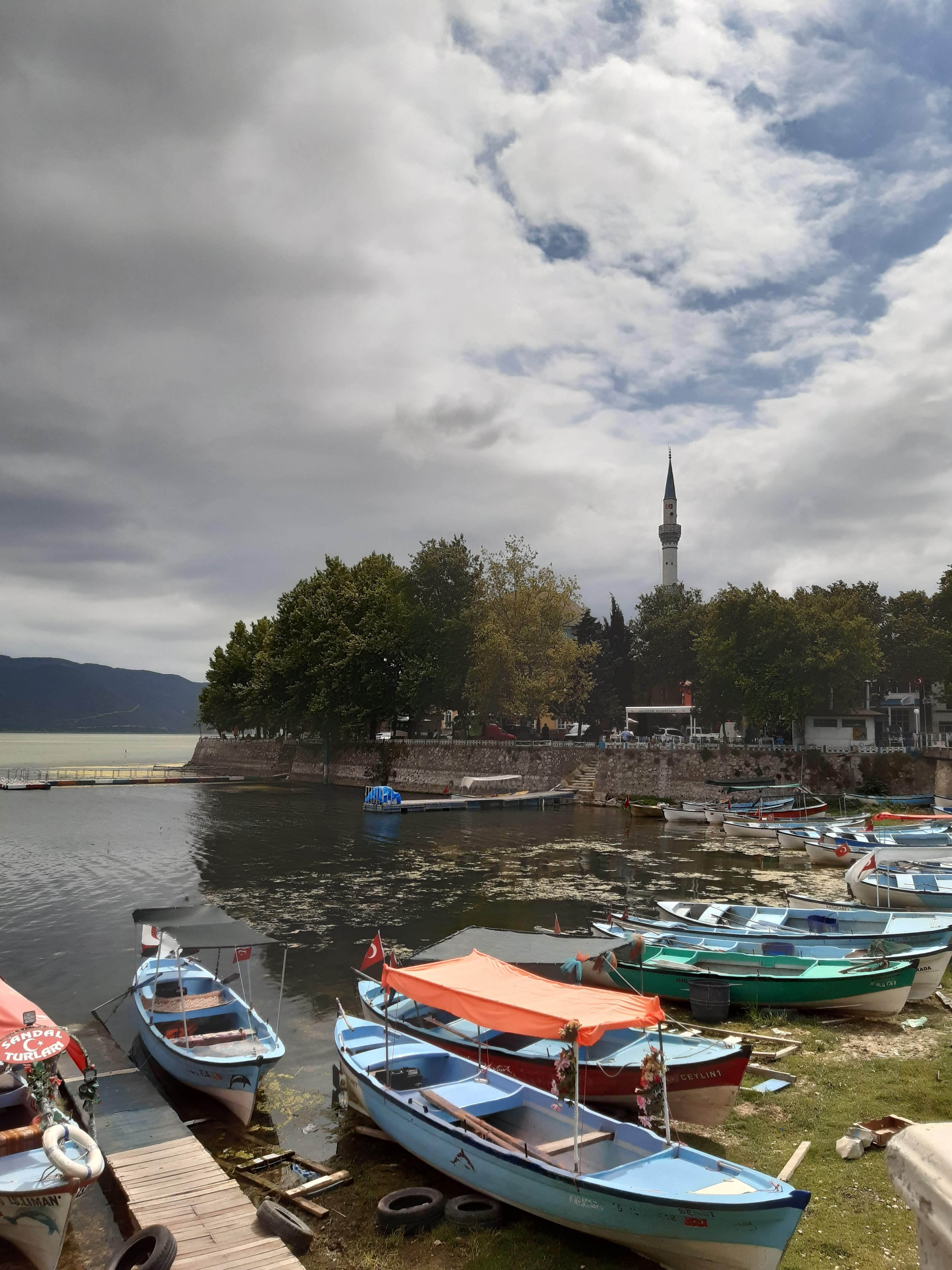 Colorful Boats Harbored by a Seaside Mosque · Free Stock Photo