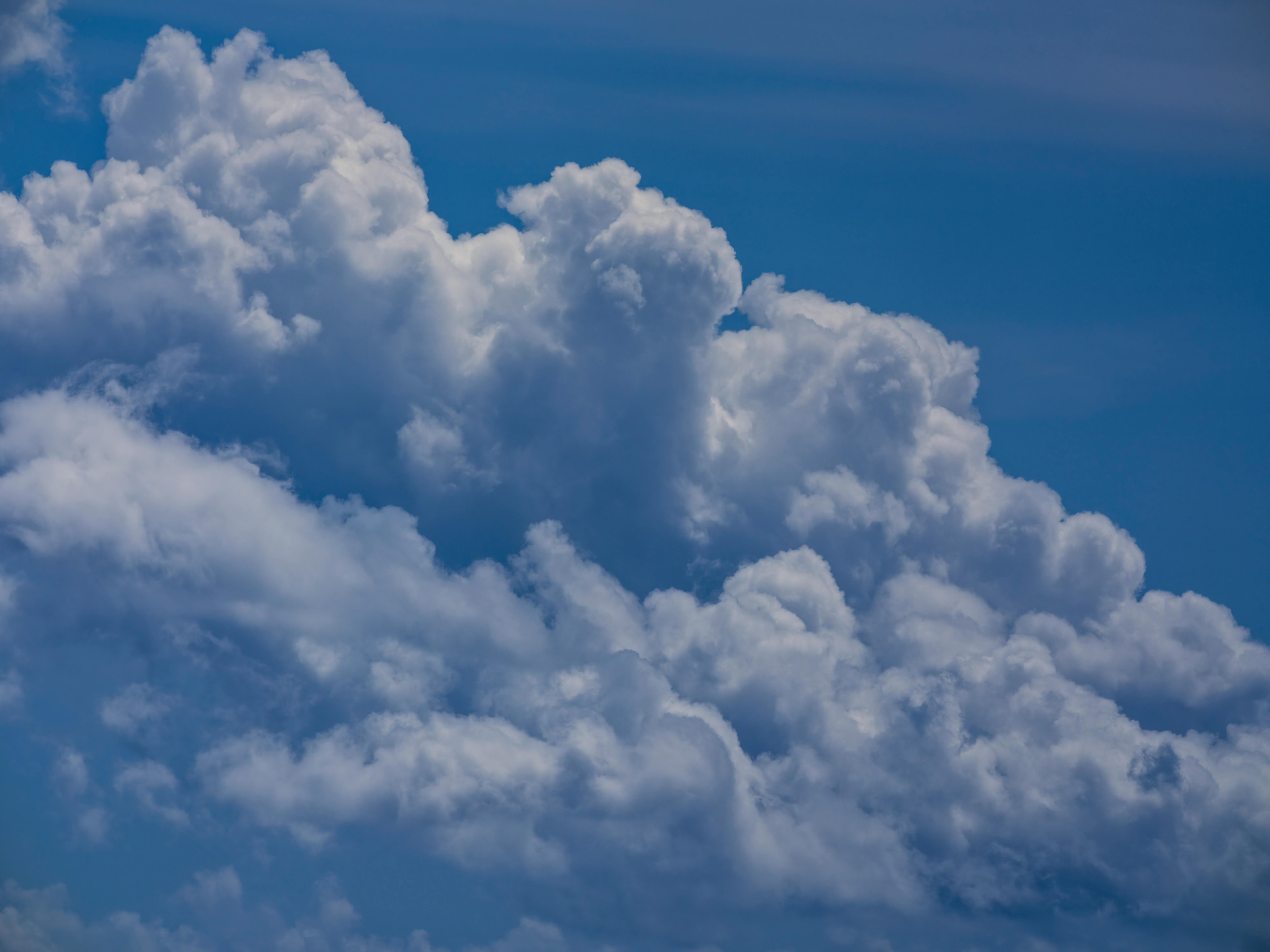 Dramatic Cumulus Clouds Against Blue Sky · Free Stock Photo