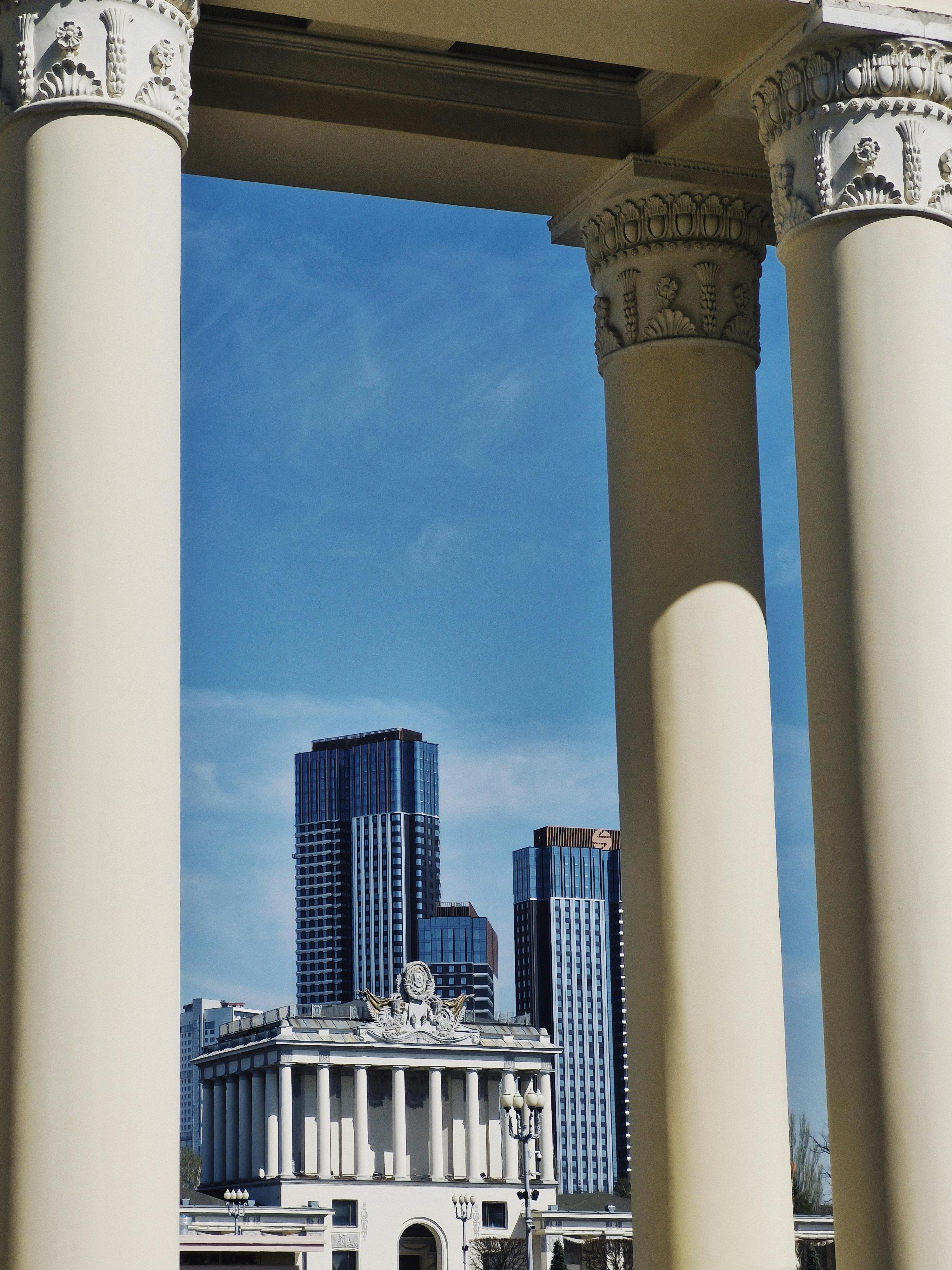 Classic Columns Frame Modern Skyscrapers · Free Stock Photo