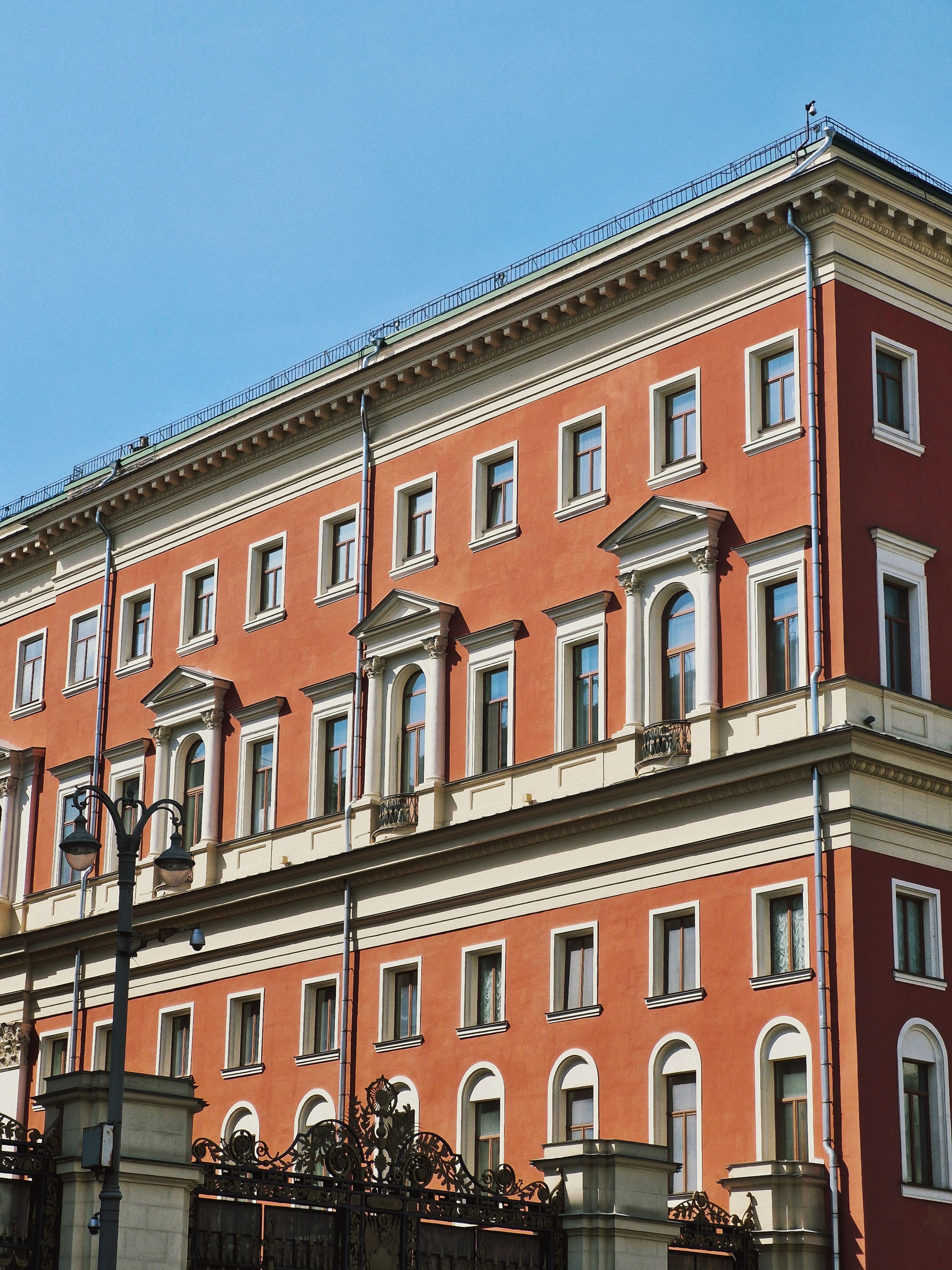 Historic Red Brick Building Under Blue Sky · Free Stock Photo