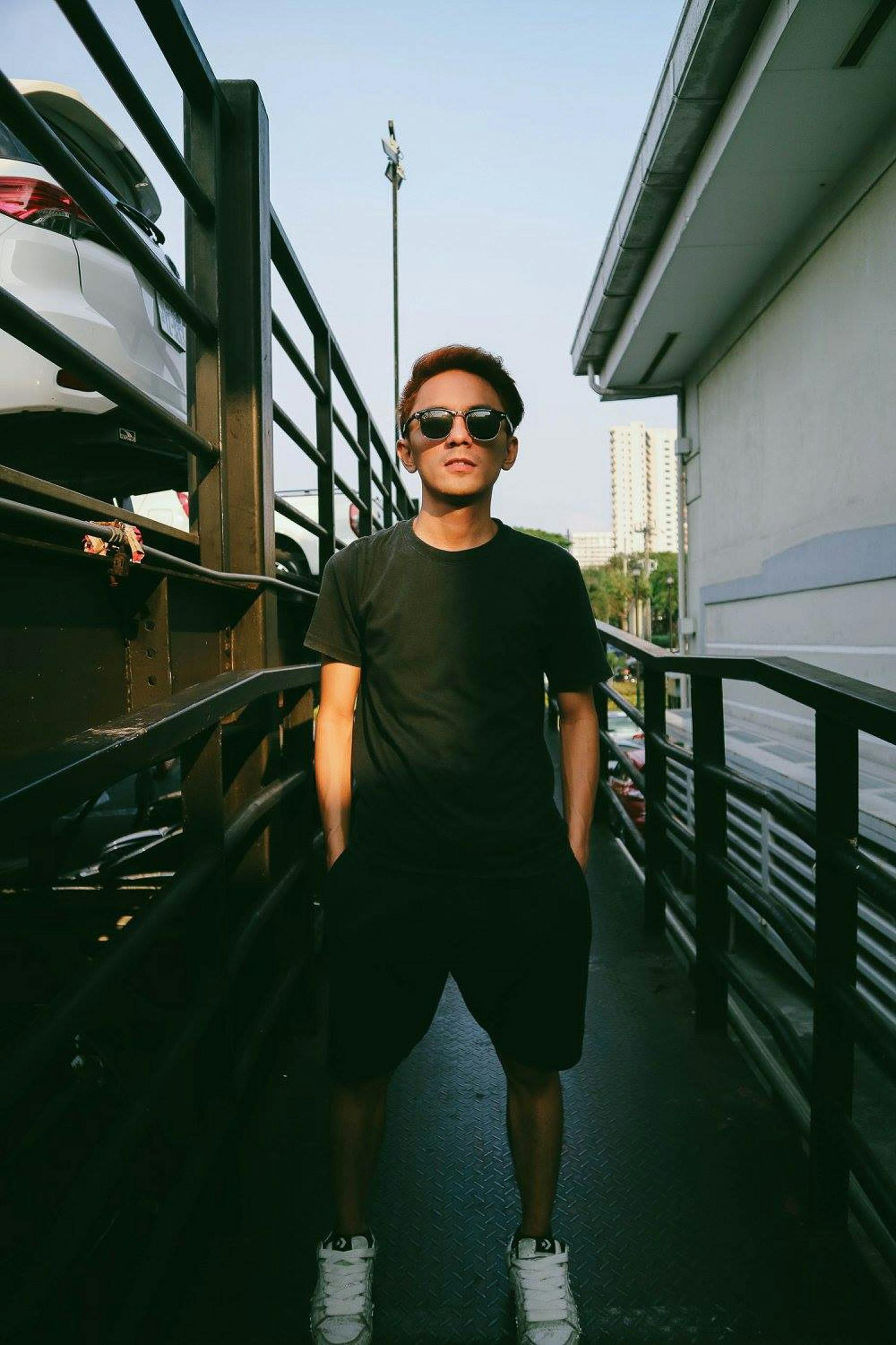 Standing Man Beside Railing · Free Stock Photo