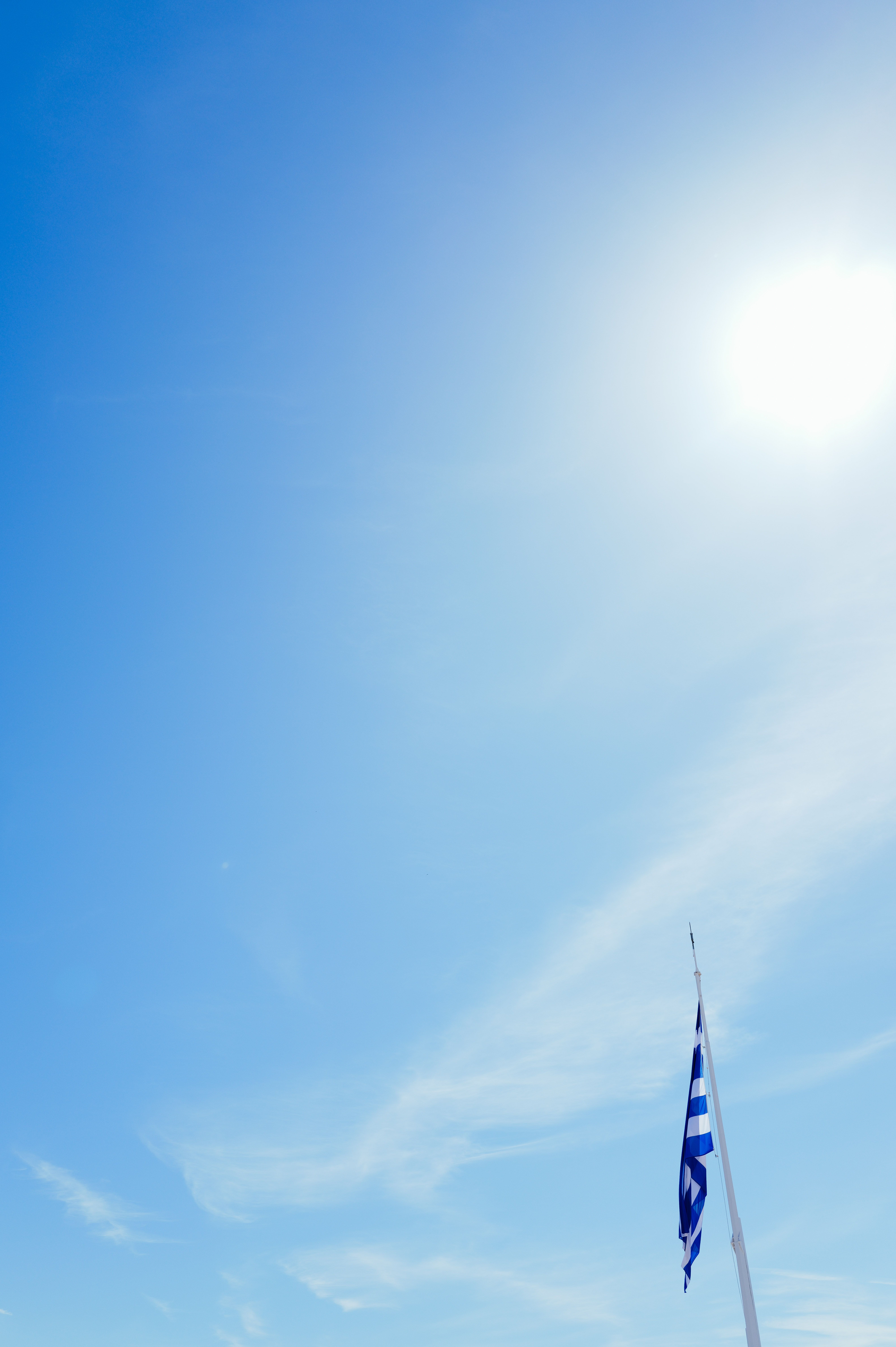 Bright Sky with Greek Flag Flying · Free Stock Photo