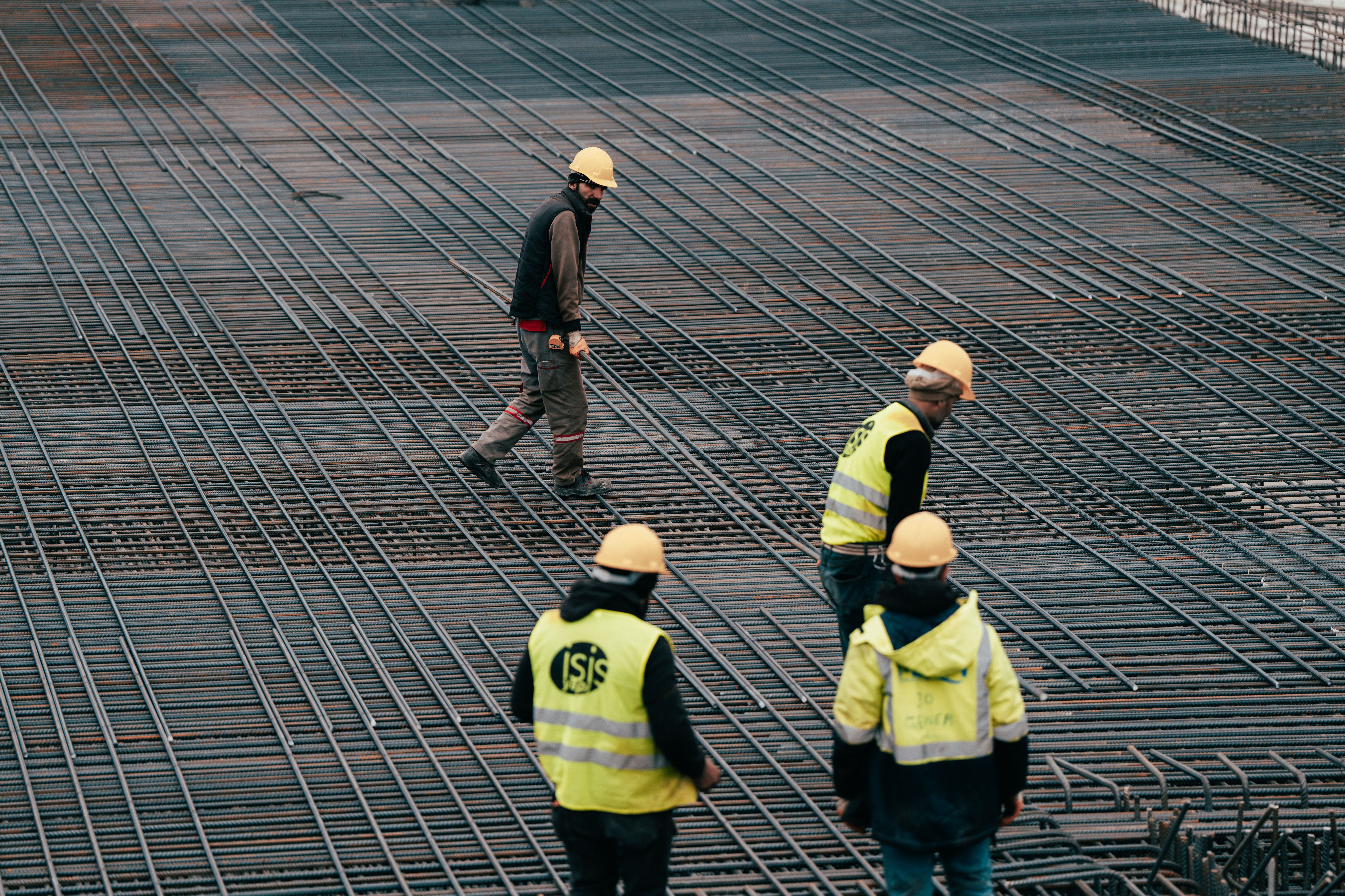 Construction Workers on Rebar Grid Site · Free Stock Photo