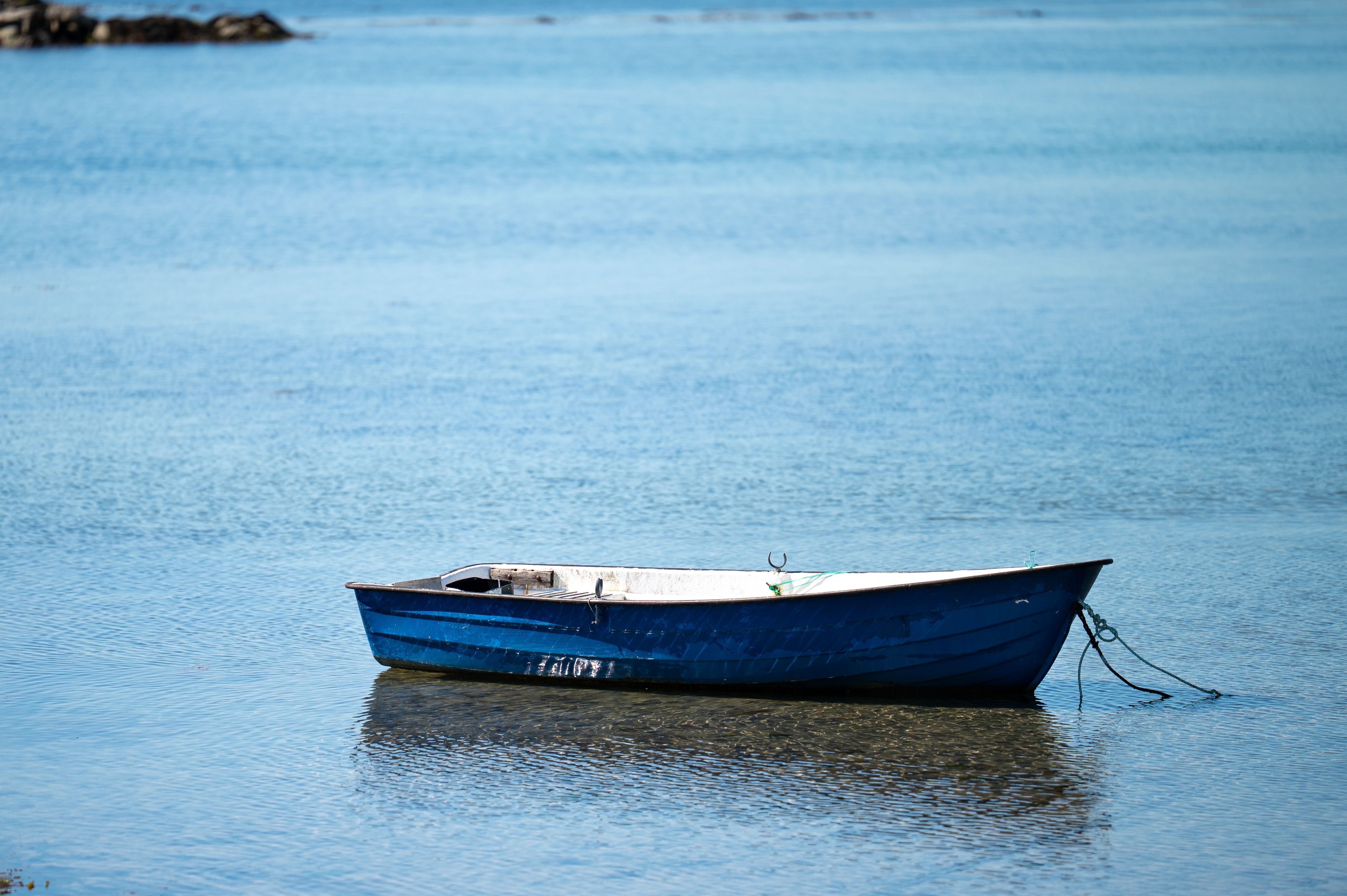 Serene Blue Boat Floating on Calm Sea · Free Stock Photo