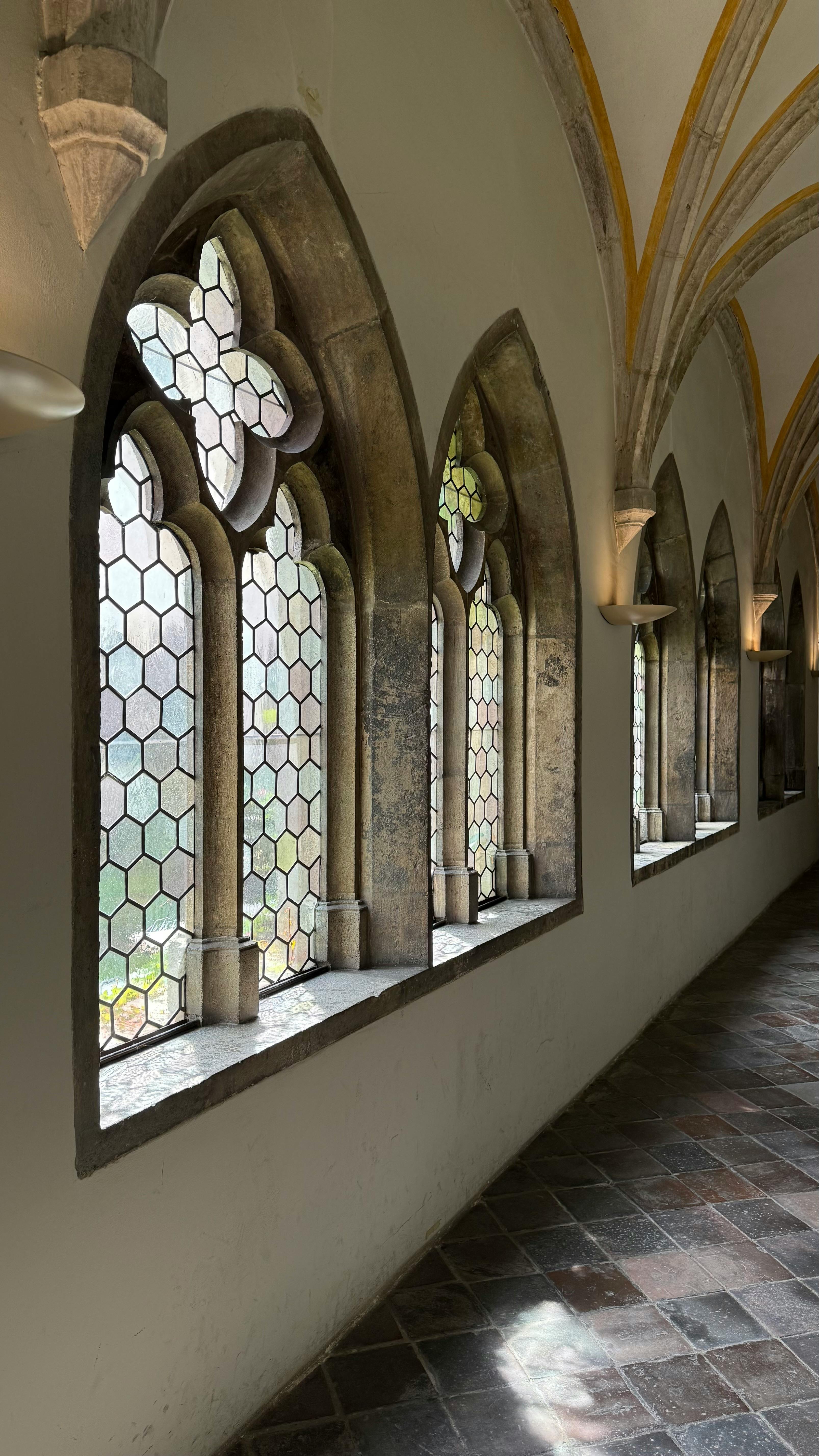 Historic Gothic Cloister with Stained Glass Windows · Free Stock Photo