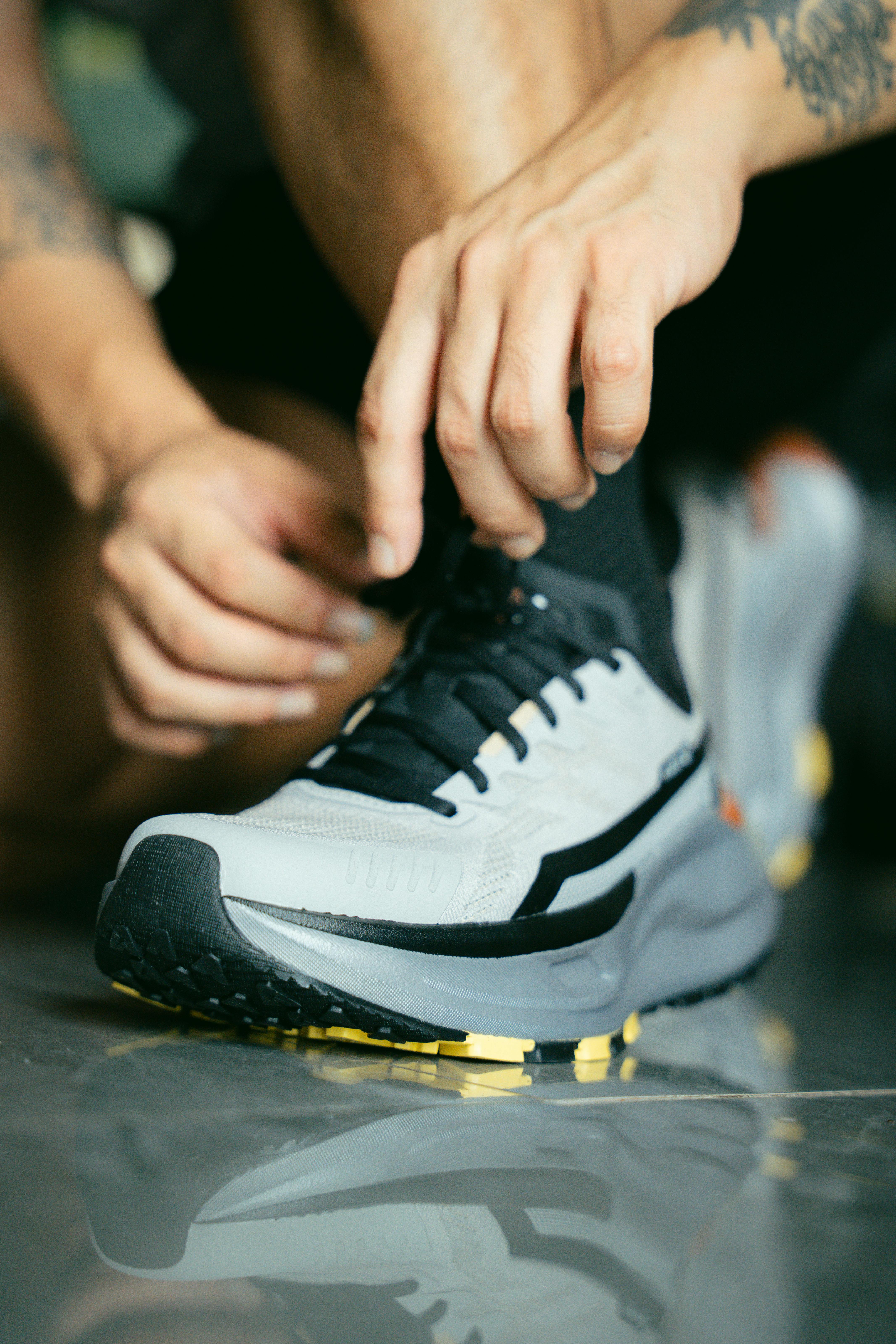 Athletic Man Tying Running Shoes Indoors · Free Stock Photo