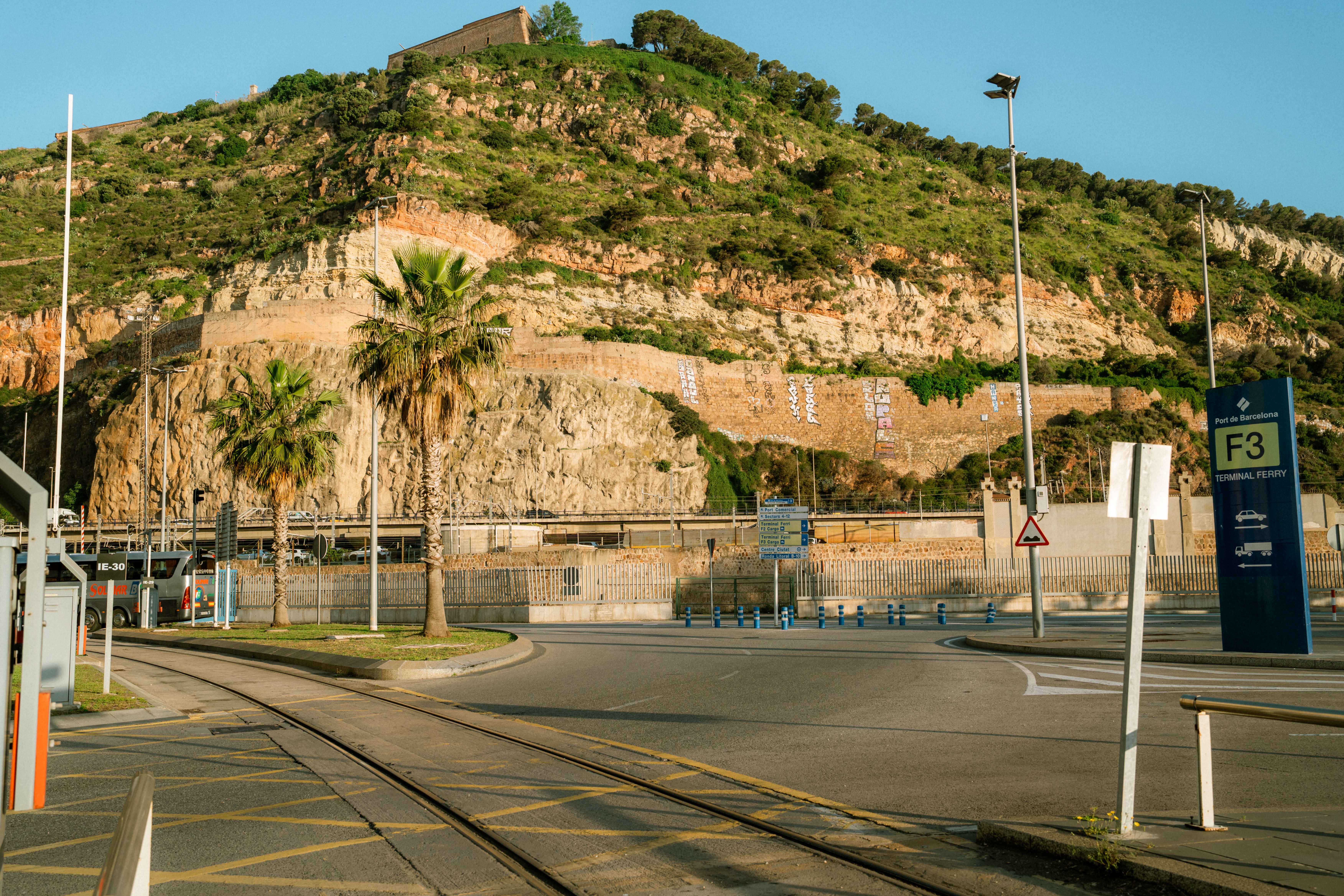 Barcelona Port Ferry Terminal with Green Hill View · Free Stock Photo
