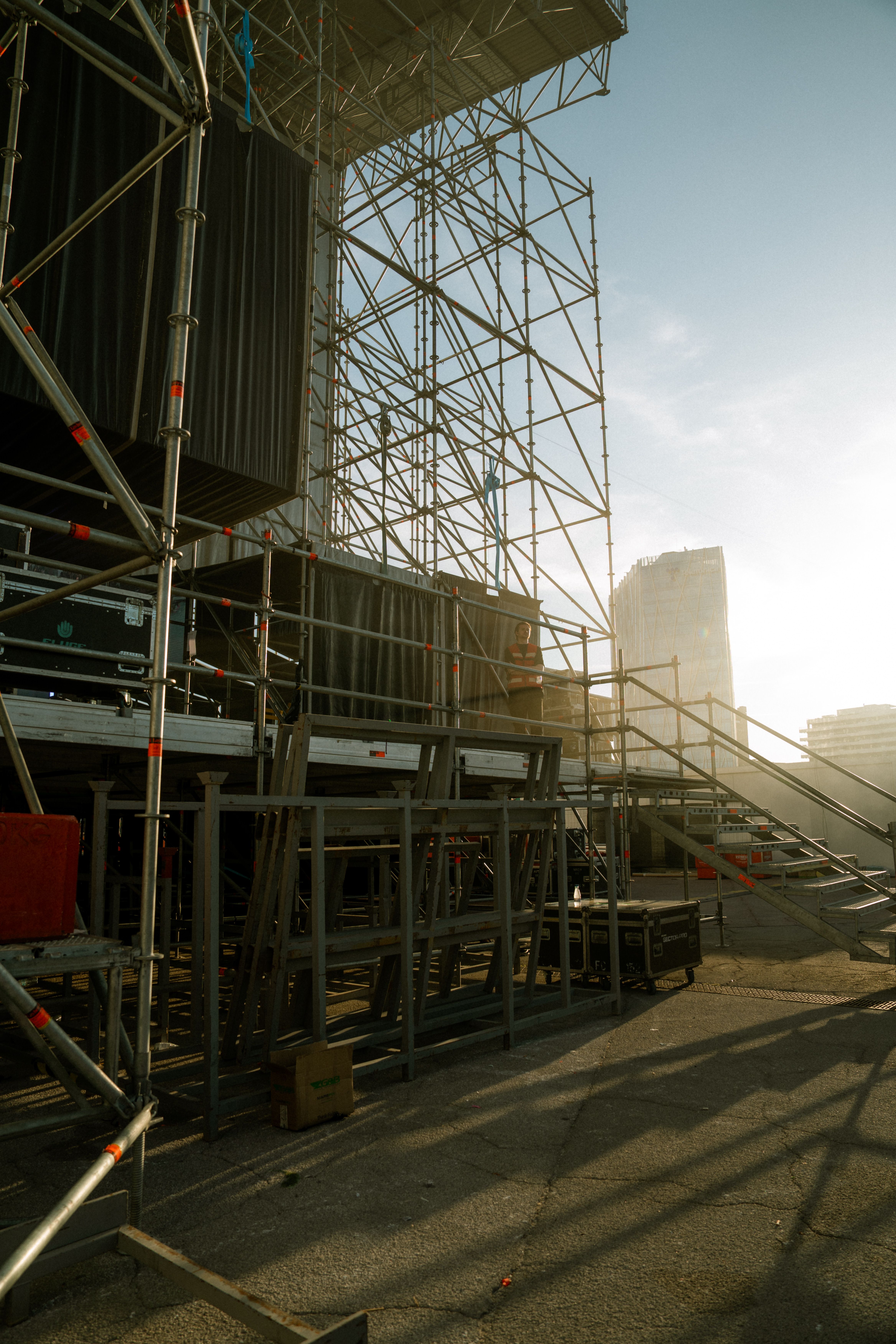 Industrial Stage Scaffolding Against Bright Sunlit Sky · Free Stock Photo