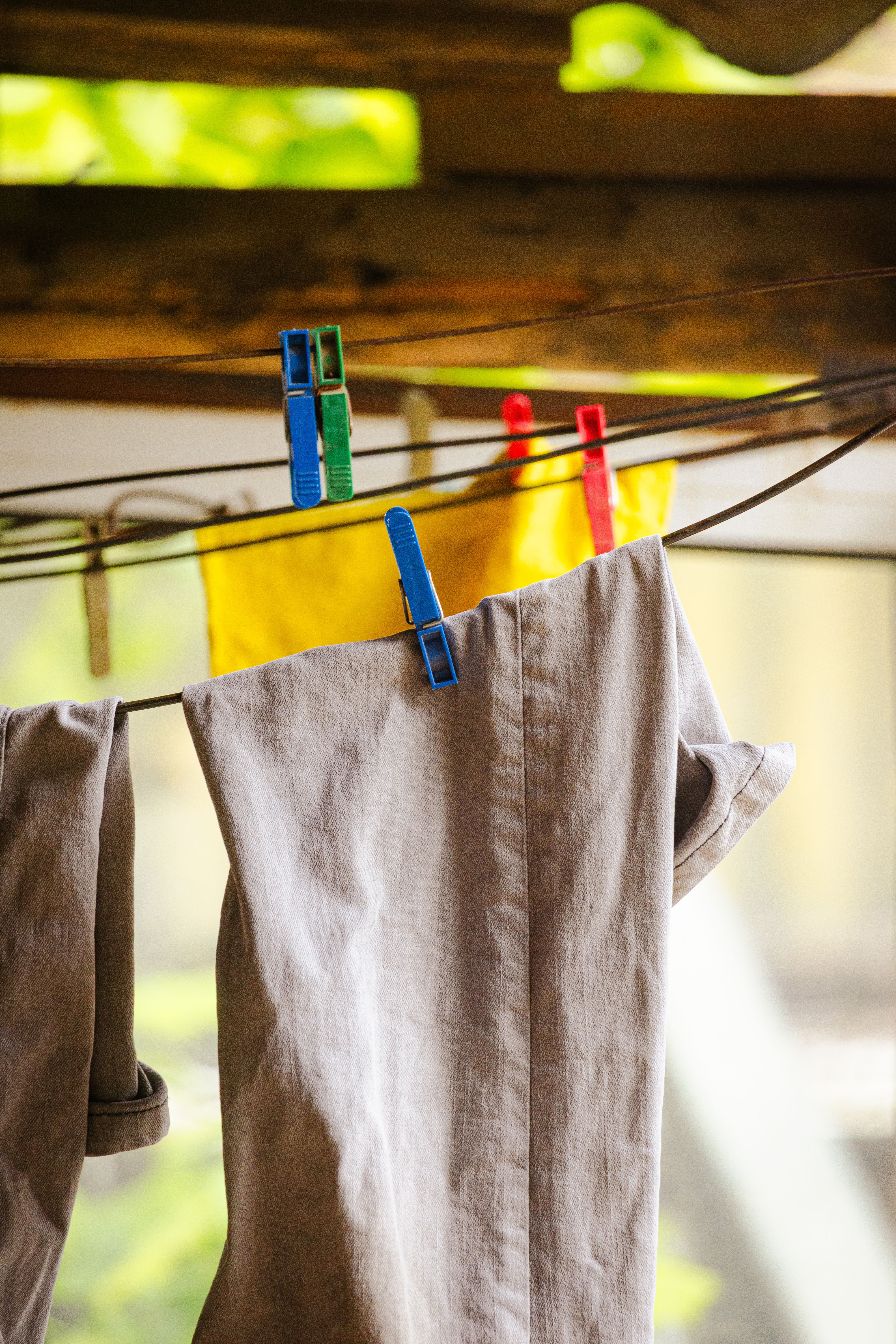 Laundry Drying on Clothesline with Colorful Pegs · Free Stock Photo