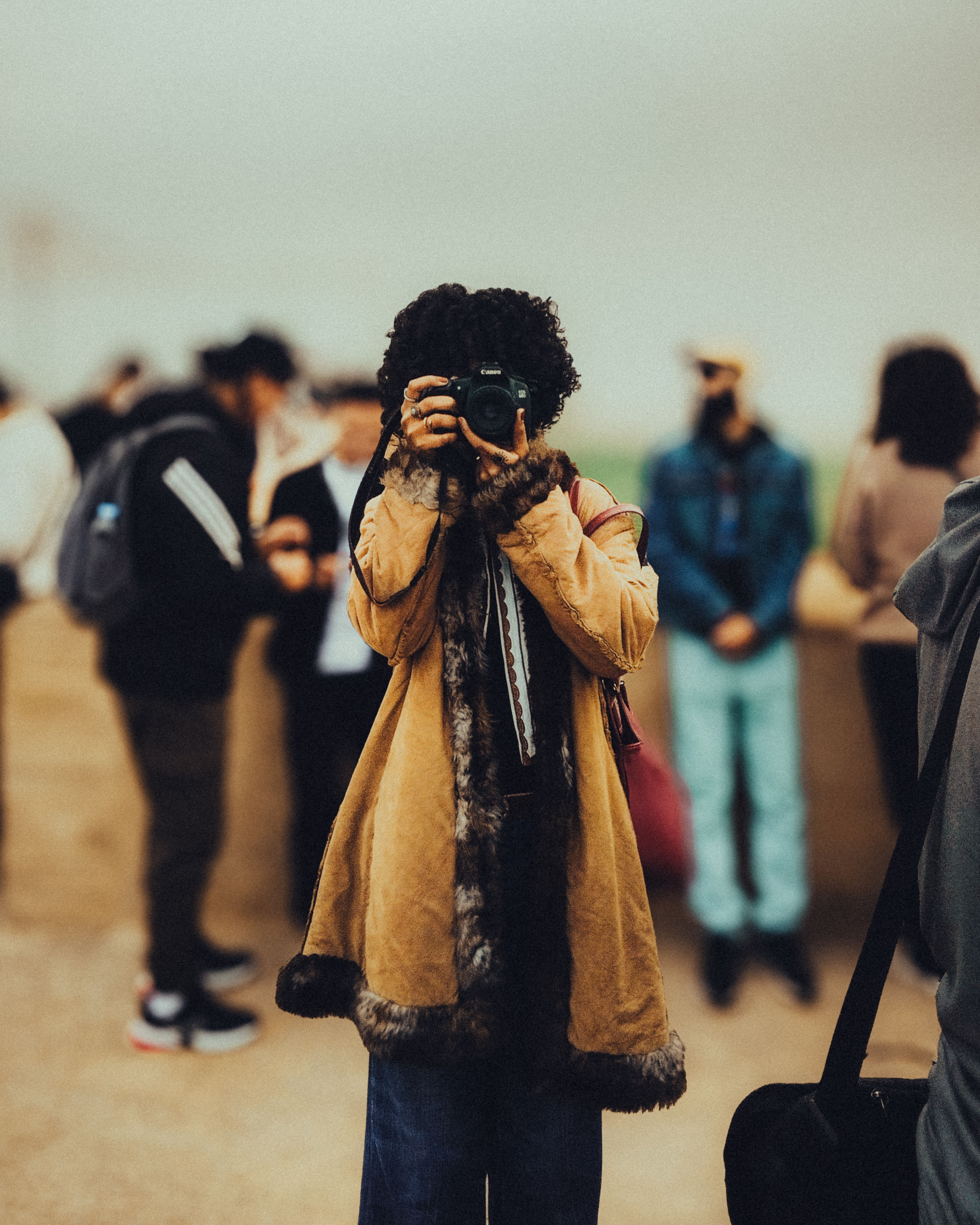 Photographer Capturing Scene in Crowded Area · Free Stock Photo
