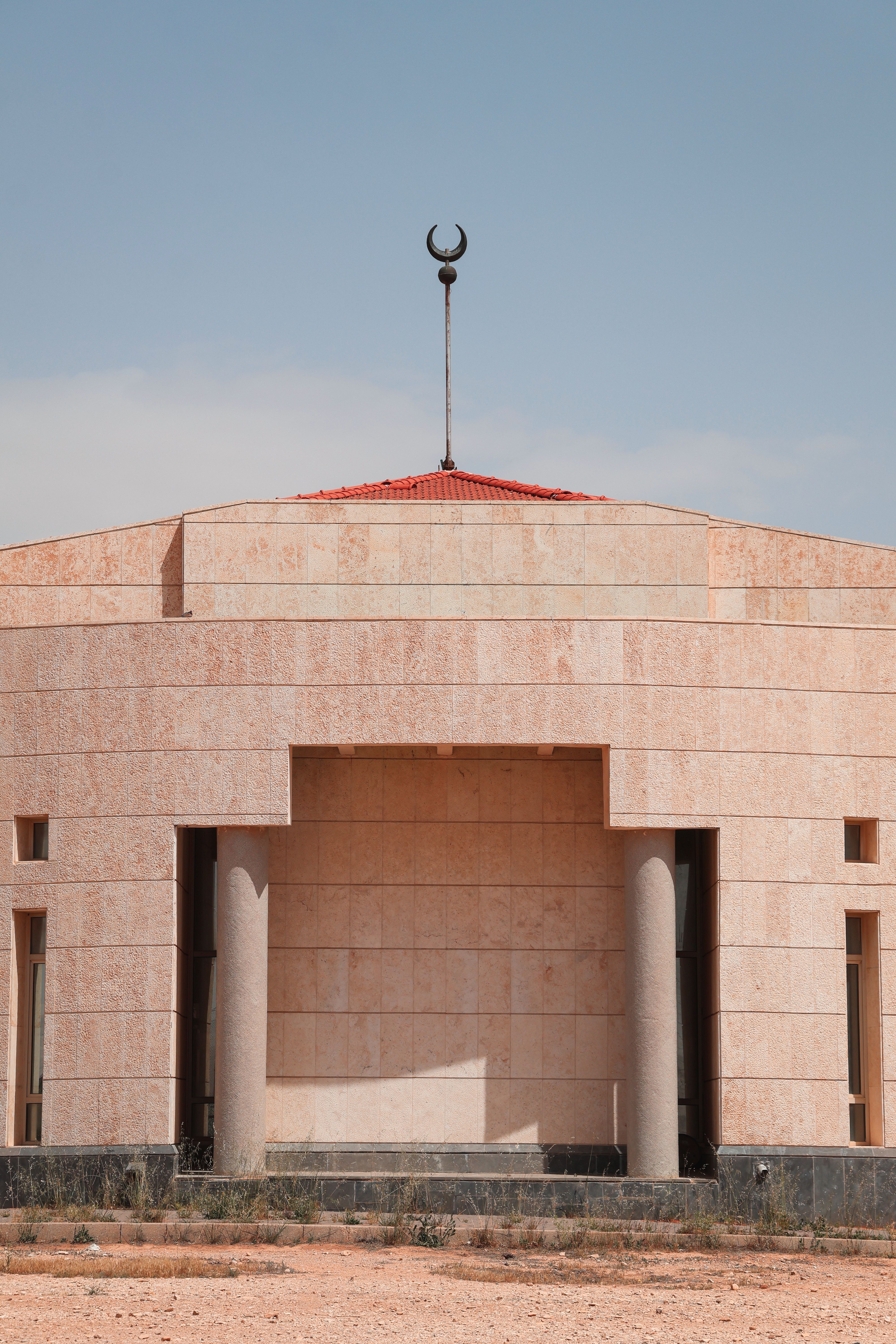 Minimalist Mosque Architecture Against Blue Sky · Free Stock Photo