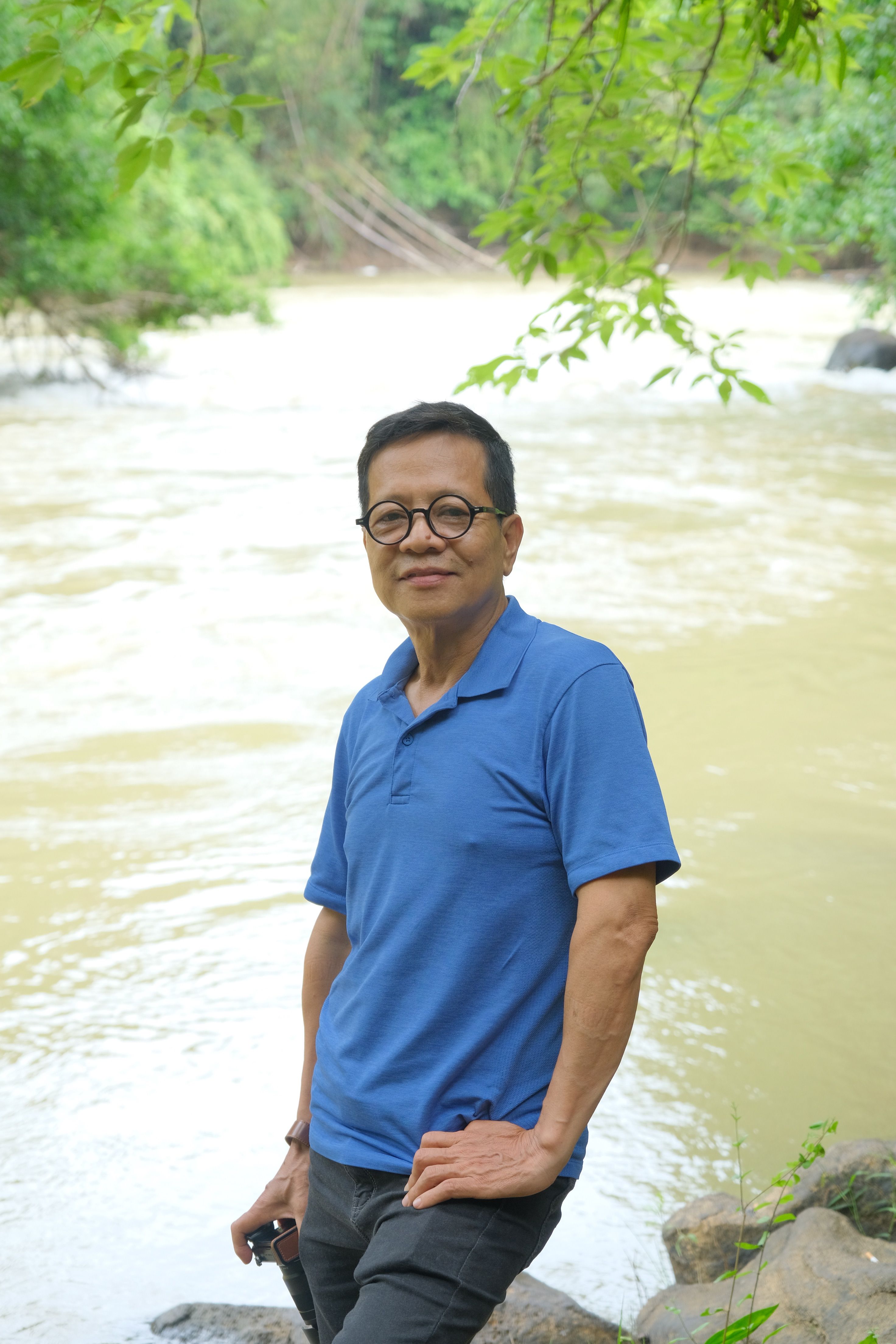 Portrait of Man by a Scenic Riverbank · Free Stock Photo