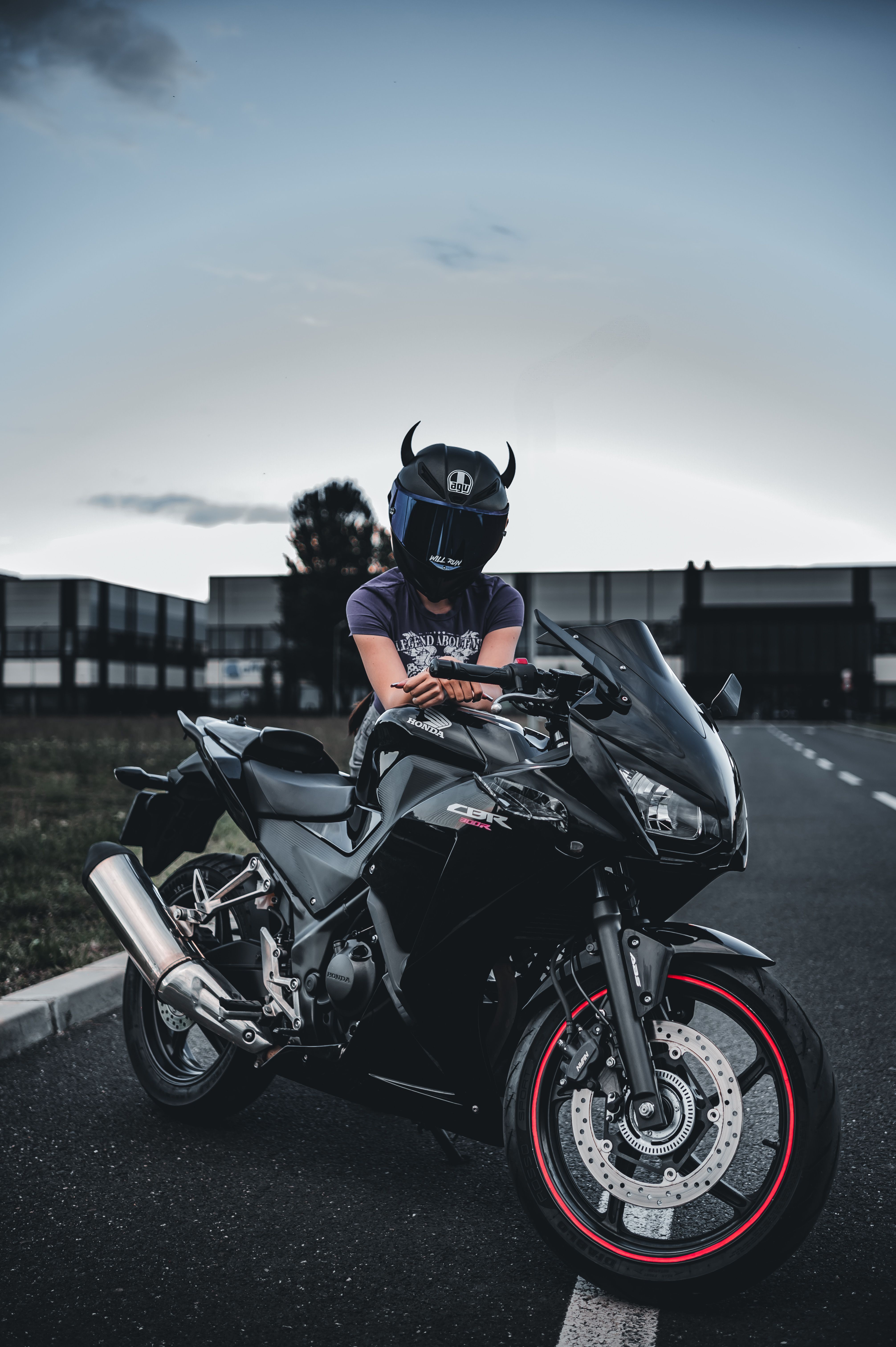 Stylish Biker Posing with Black Sport Motorcycle · Free Stock Photo