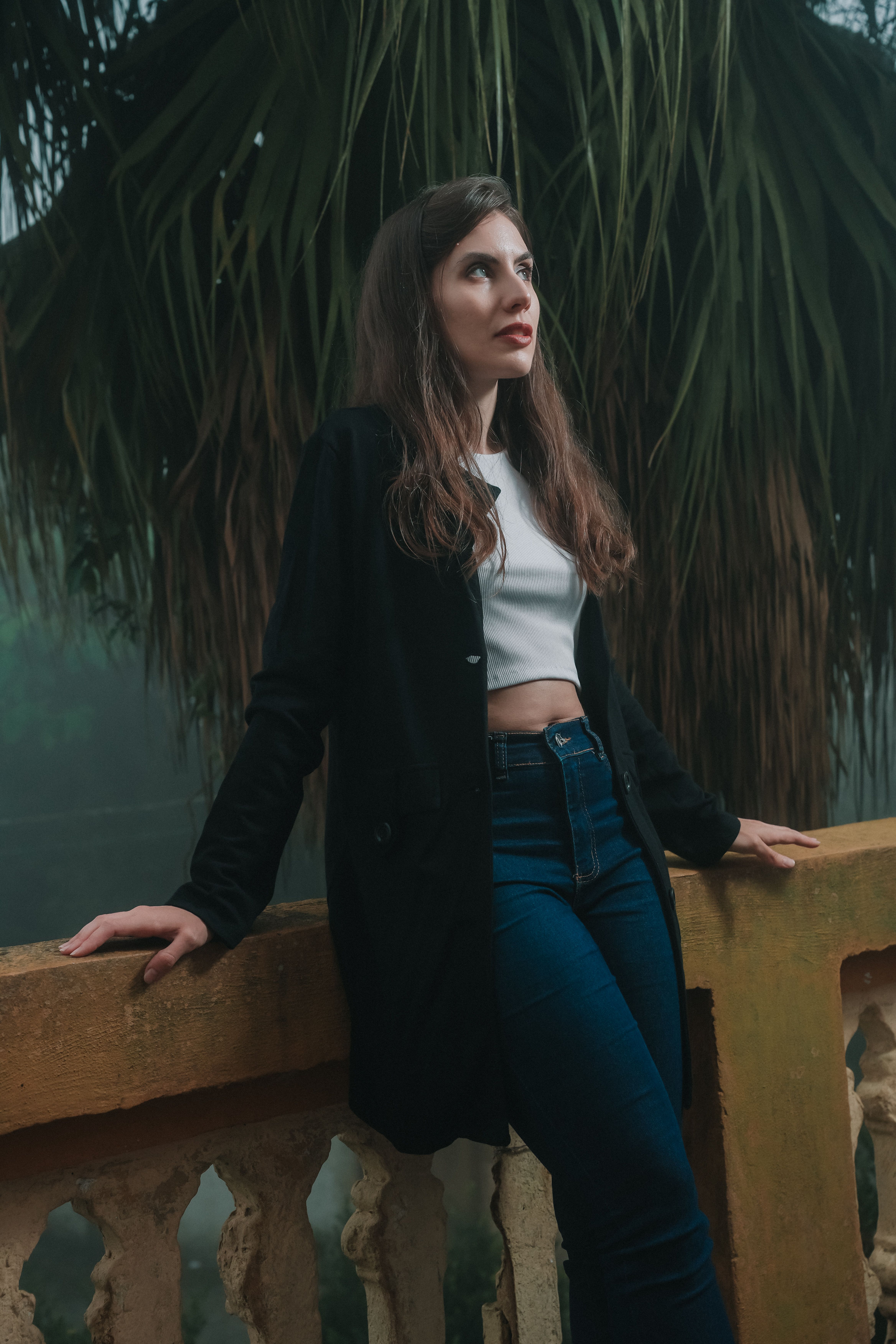 Woman Posing by Tropical Backdrop in Casual Outfit · Free Stock Photo