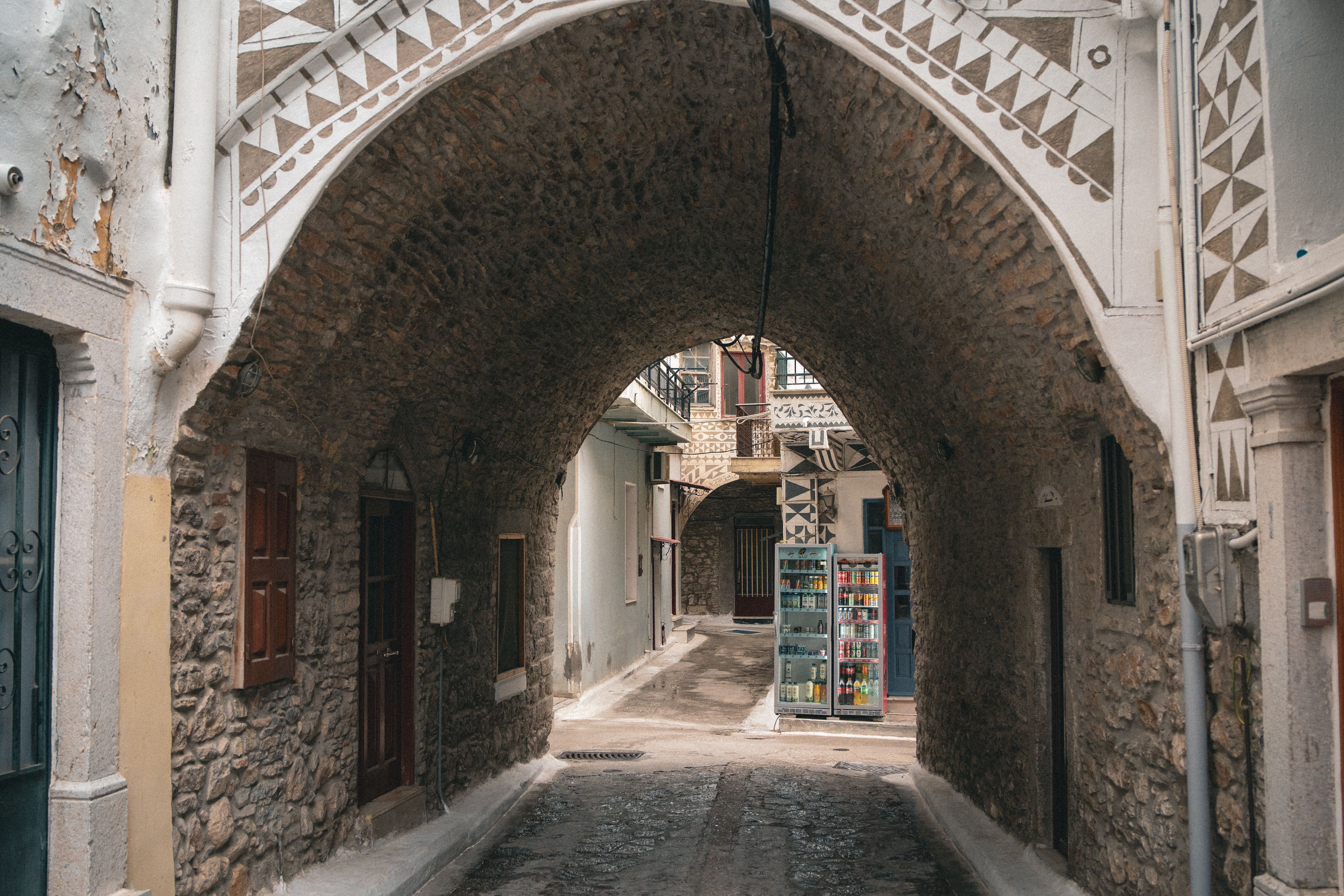 Charming Narrow Stone Alleyway with Arched Roof · Free Stock Photo