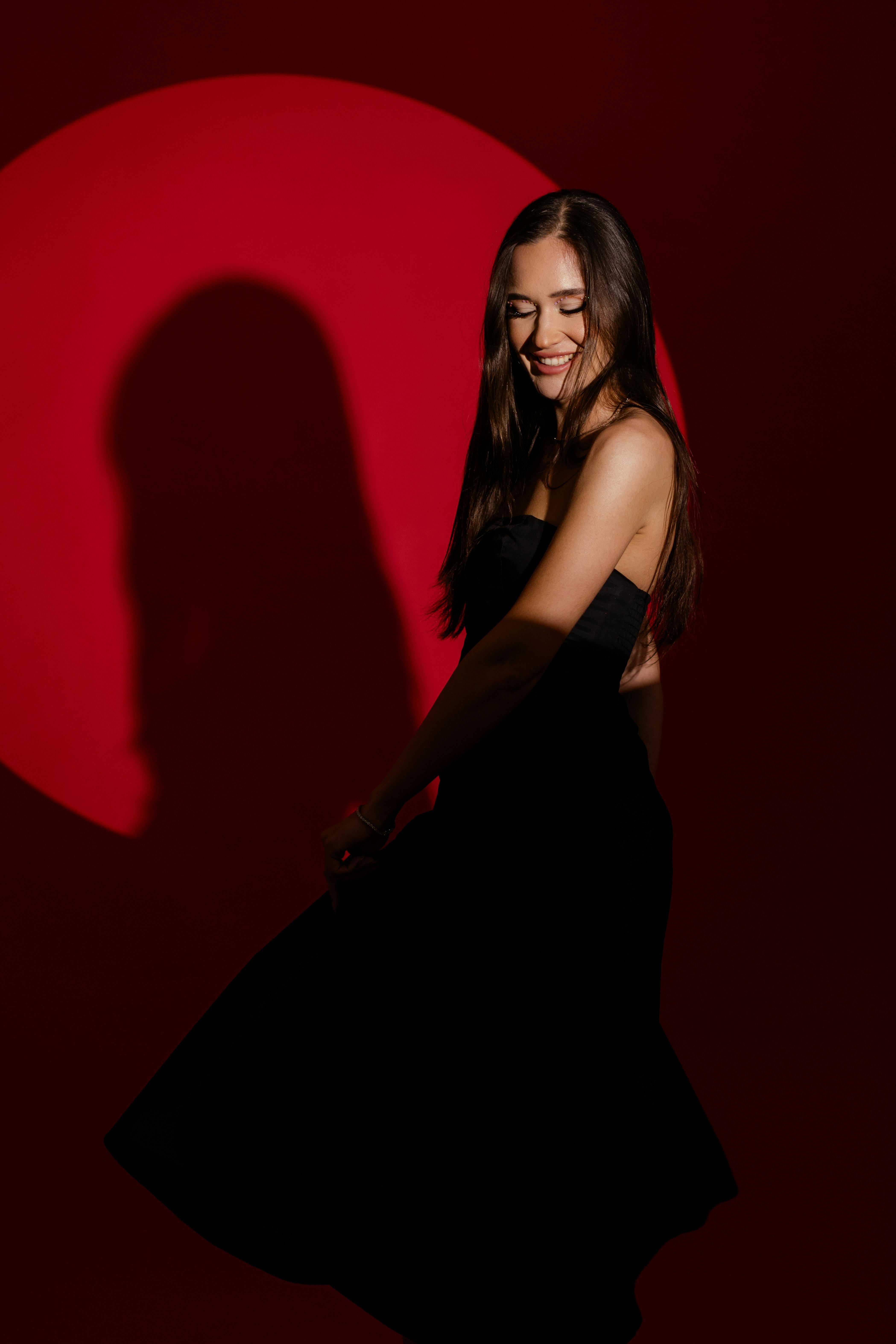 Elegant Woman Dancing in Dramatic Red Lighting · Free Stock Photo