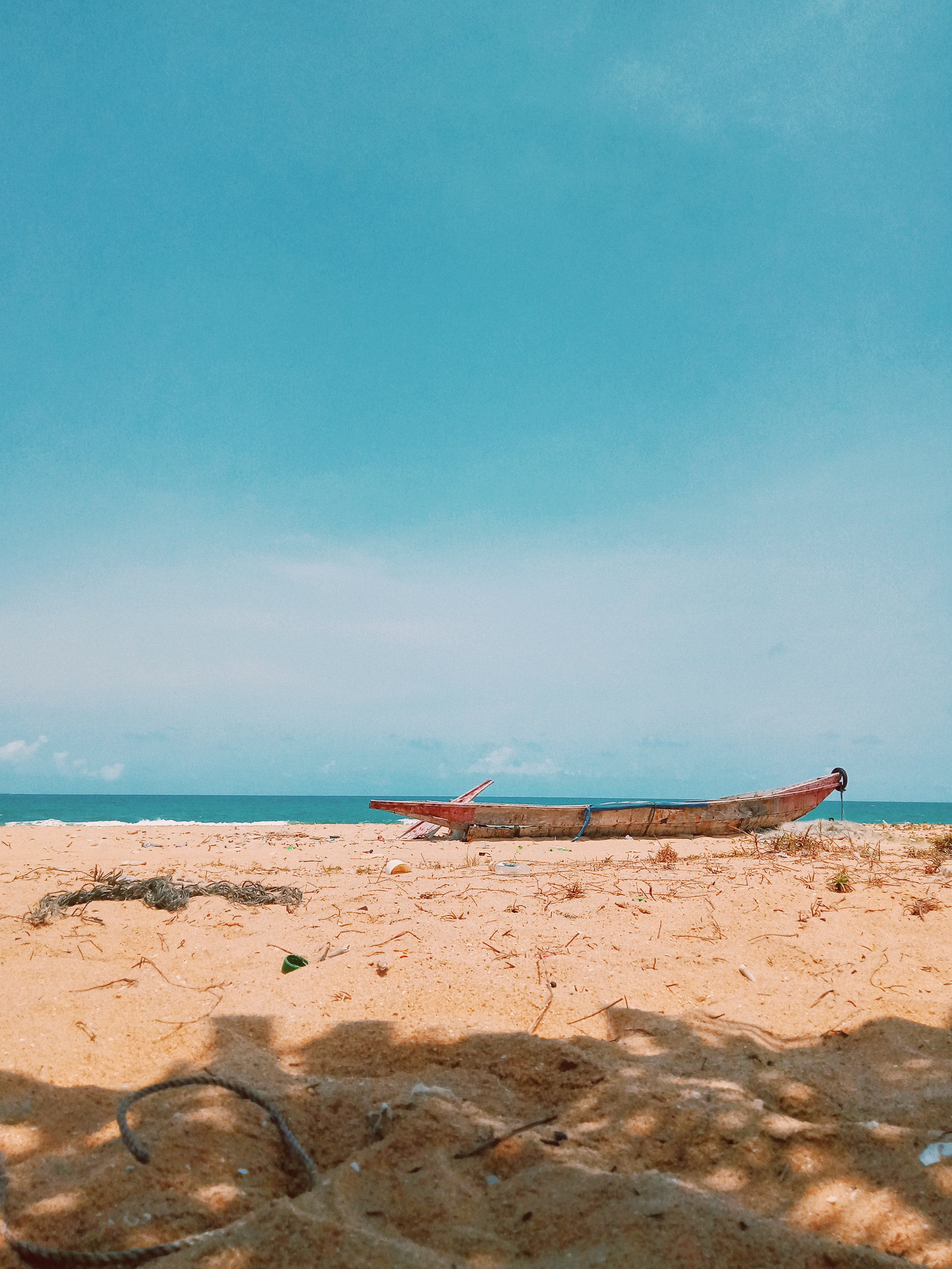 Serene Beach Scene with Boat in Lagos, Nigeria · Free Stock Photo
