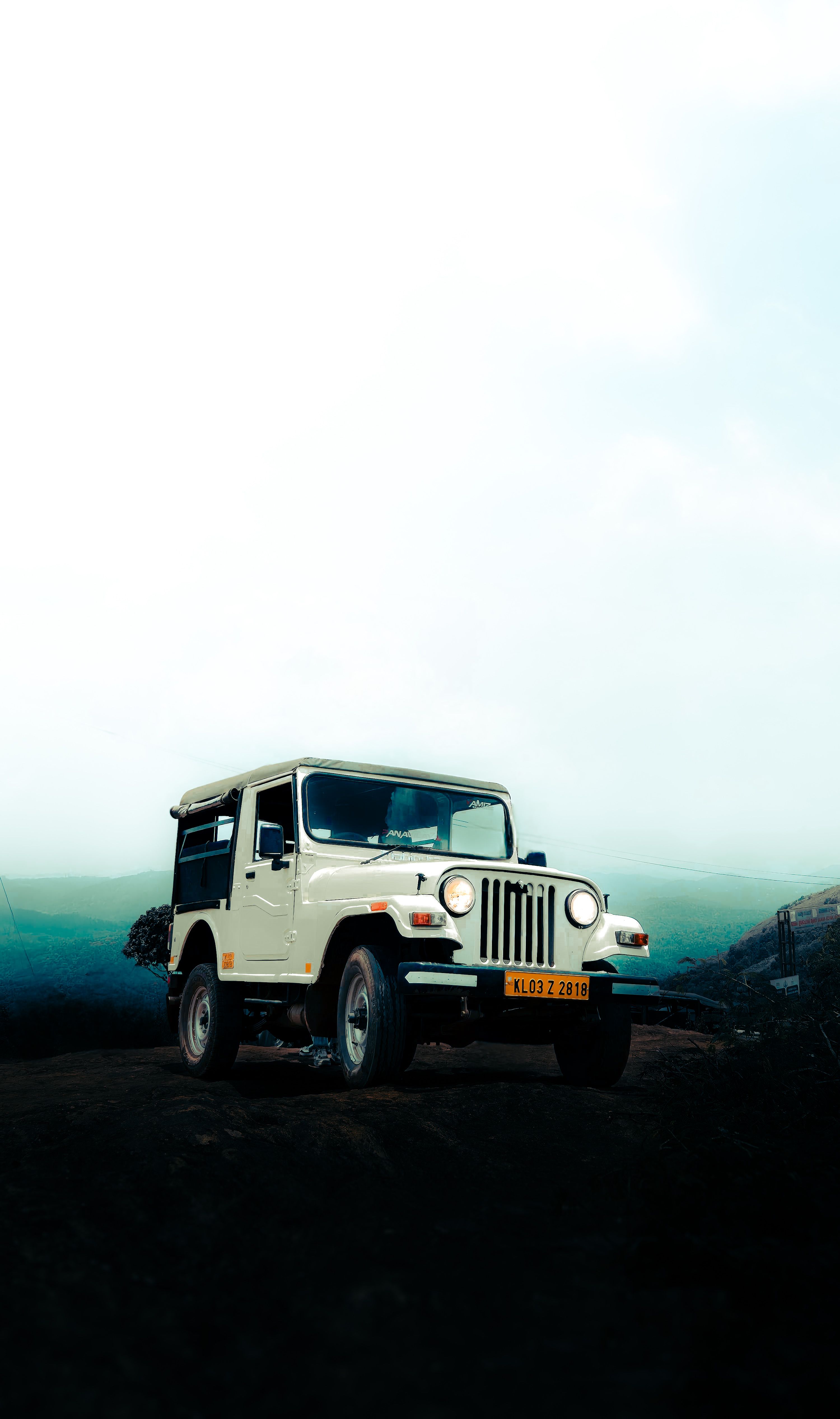 Classic Off-Road Vehicle in Misty Landscape · Free Stock Photo