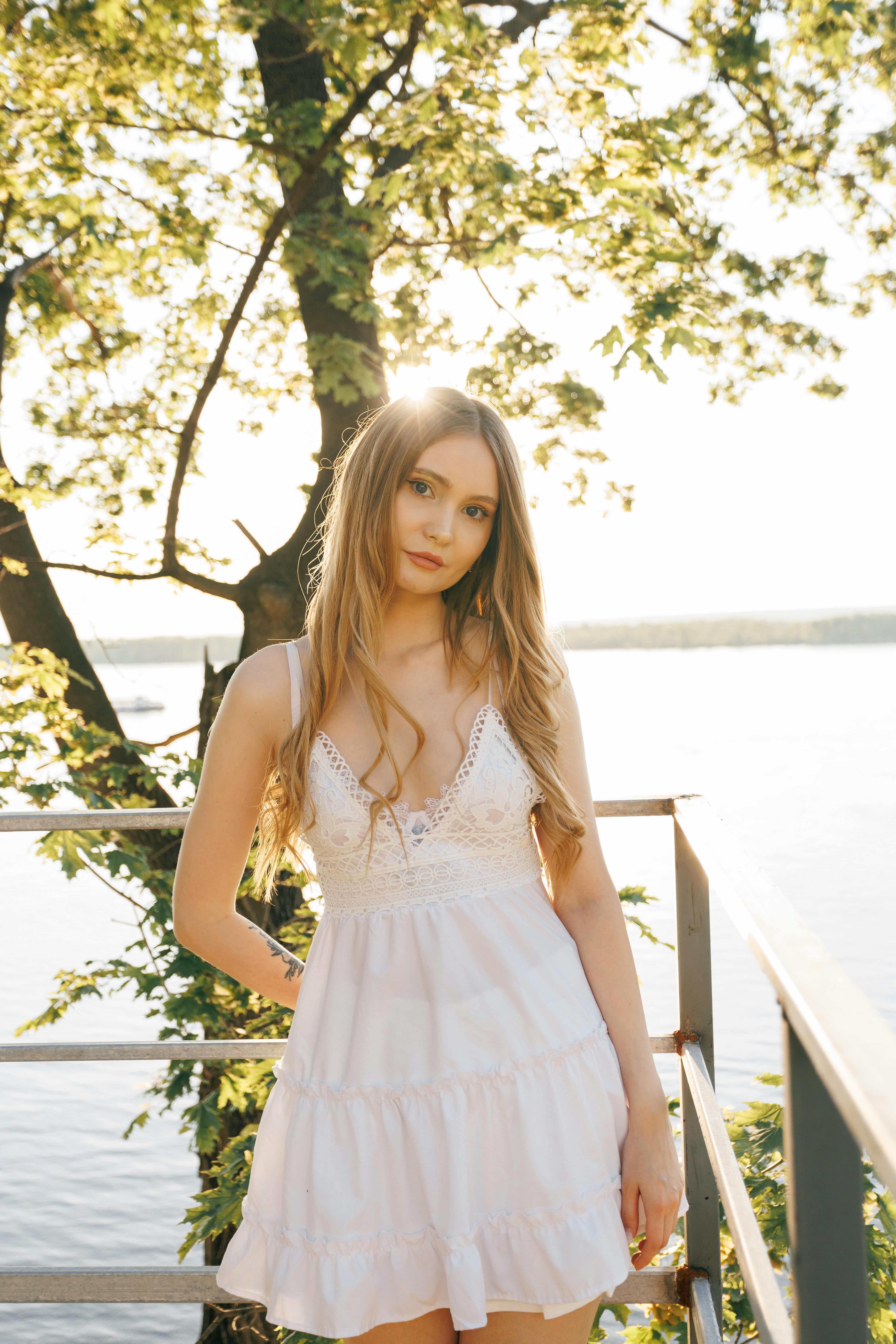 Sunlit Portrait of Woman by the Lake · Free Stock Photo