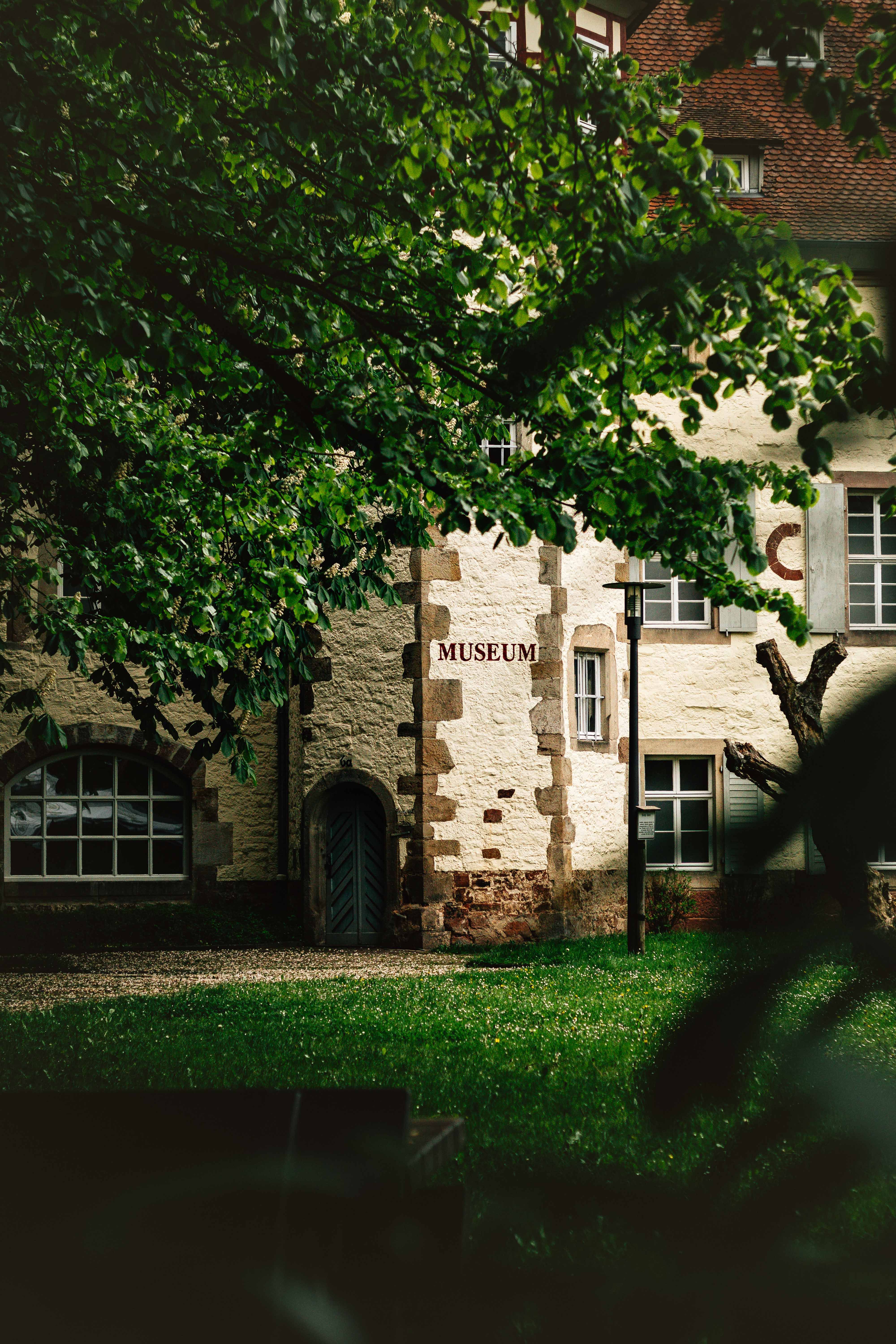 Charming Rural Museum Exterior with Greenery · Free Stock Photo