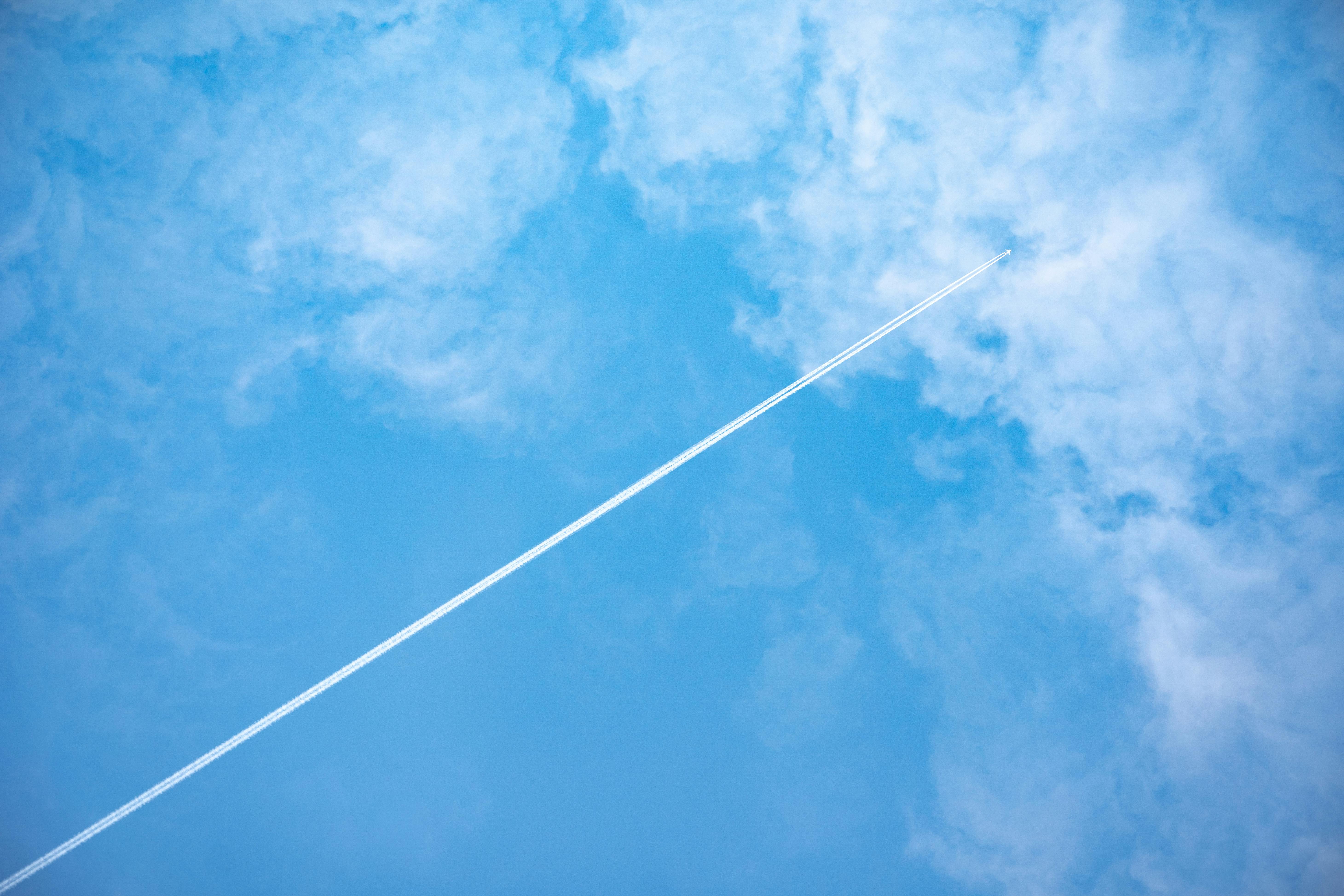 Jet Contrail Across a Clear Blue Sky · Free Stock Photo