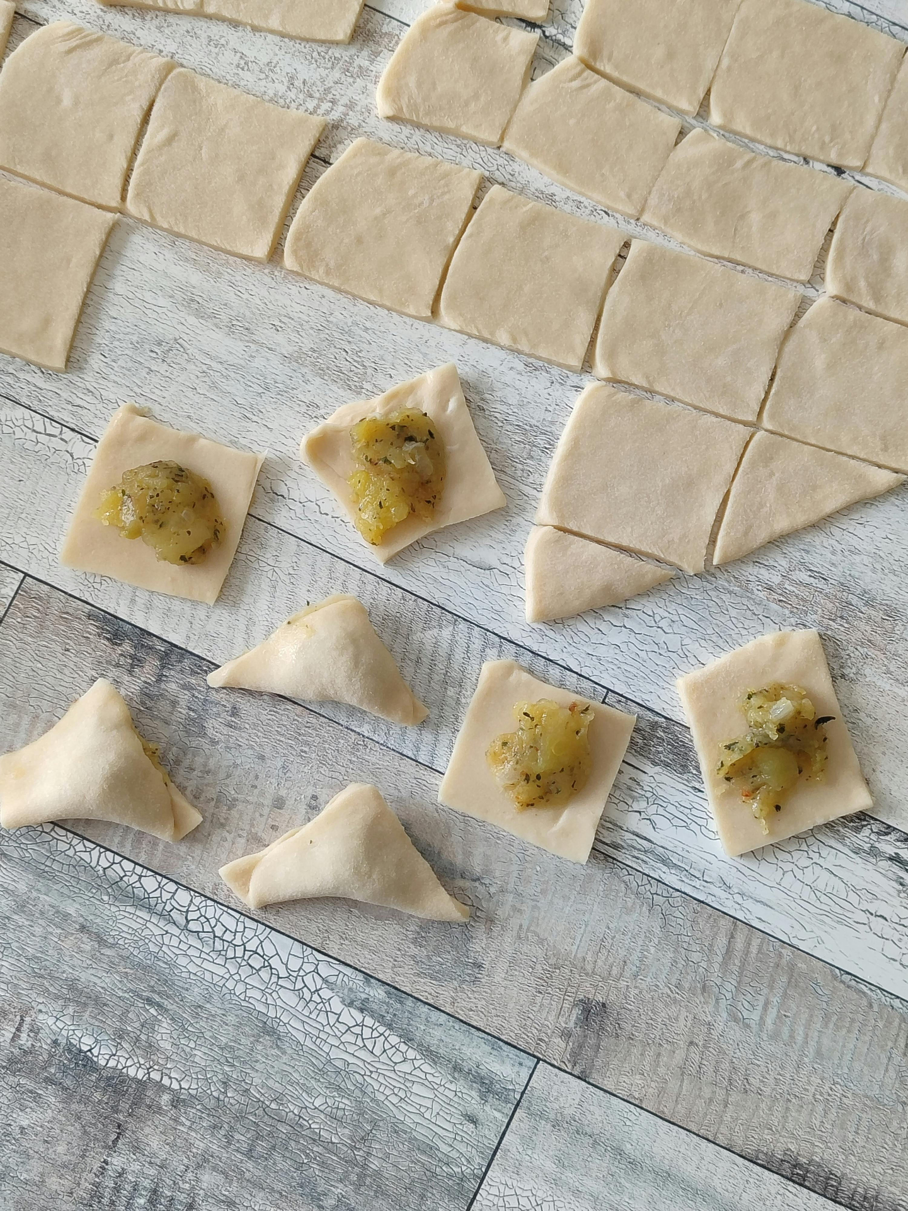 Preparing homemade samosas with potato filling · Free Stock Photo