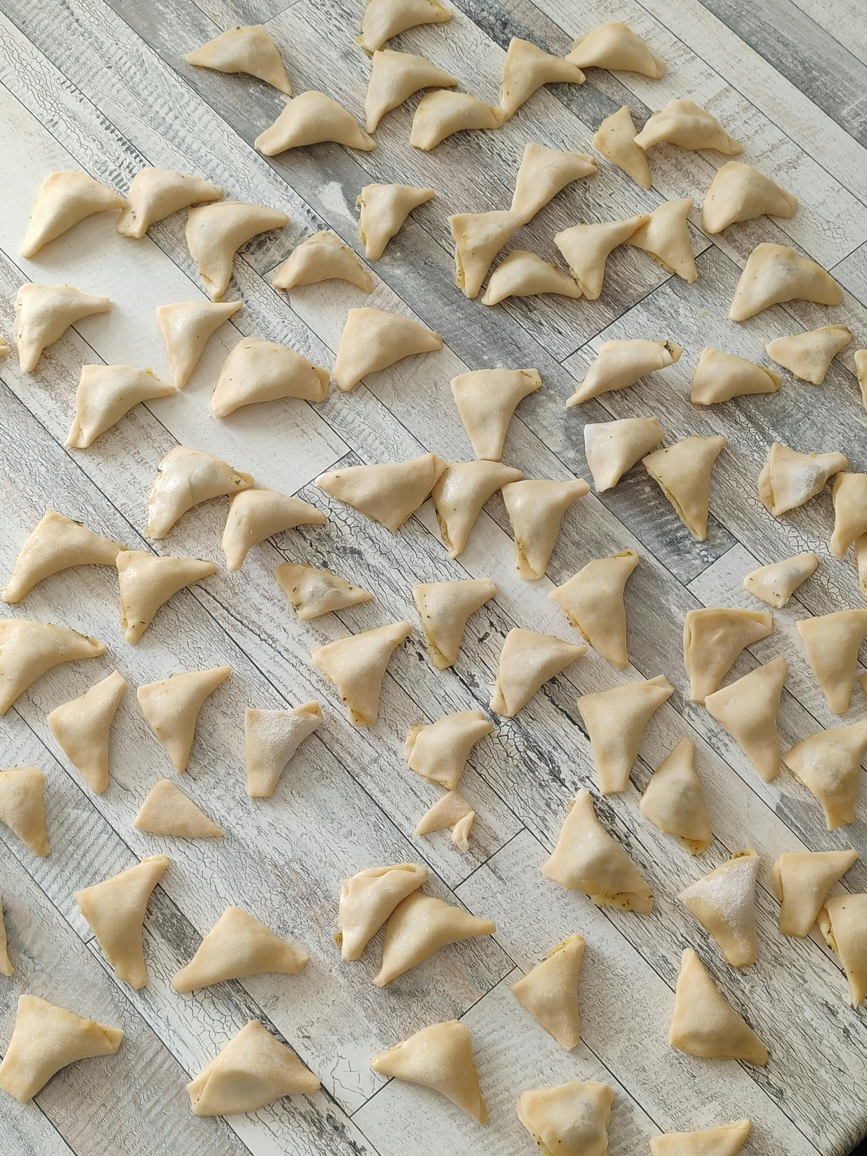 Freshly Prepared Triangle-Shaped Pastries on Wooden Surface · Free ...