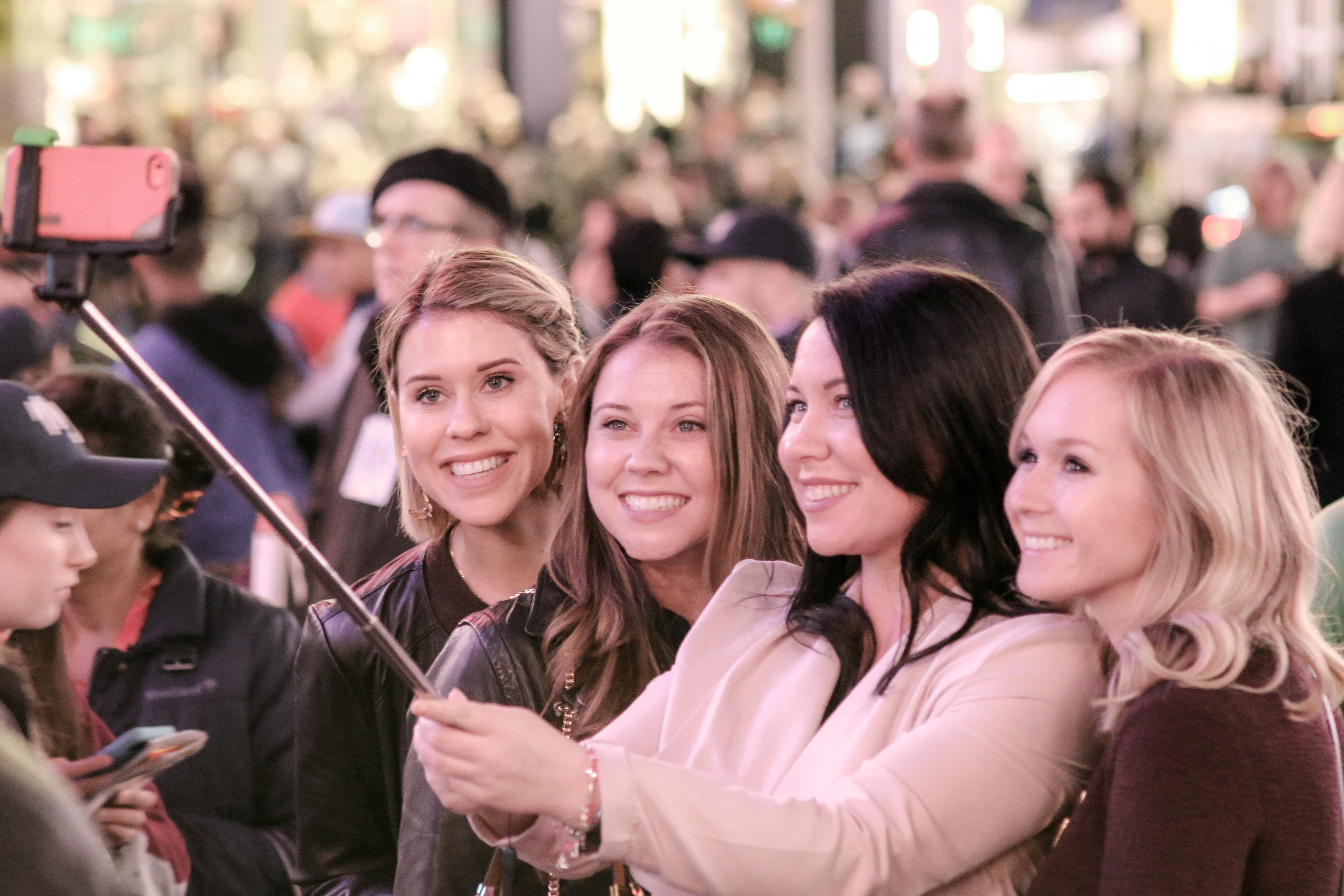 Group of Friends Taking a Selfie in a Crowded Urban Area · Free Stock Photo