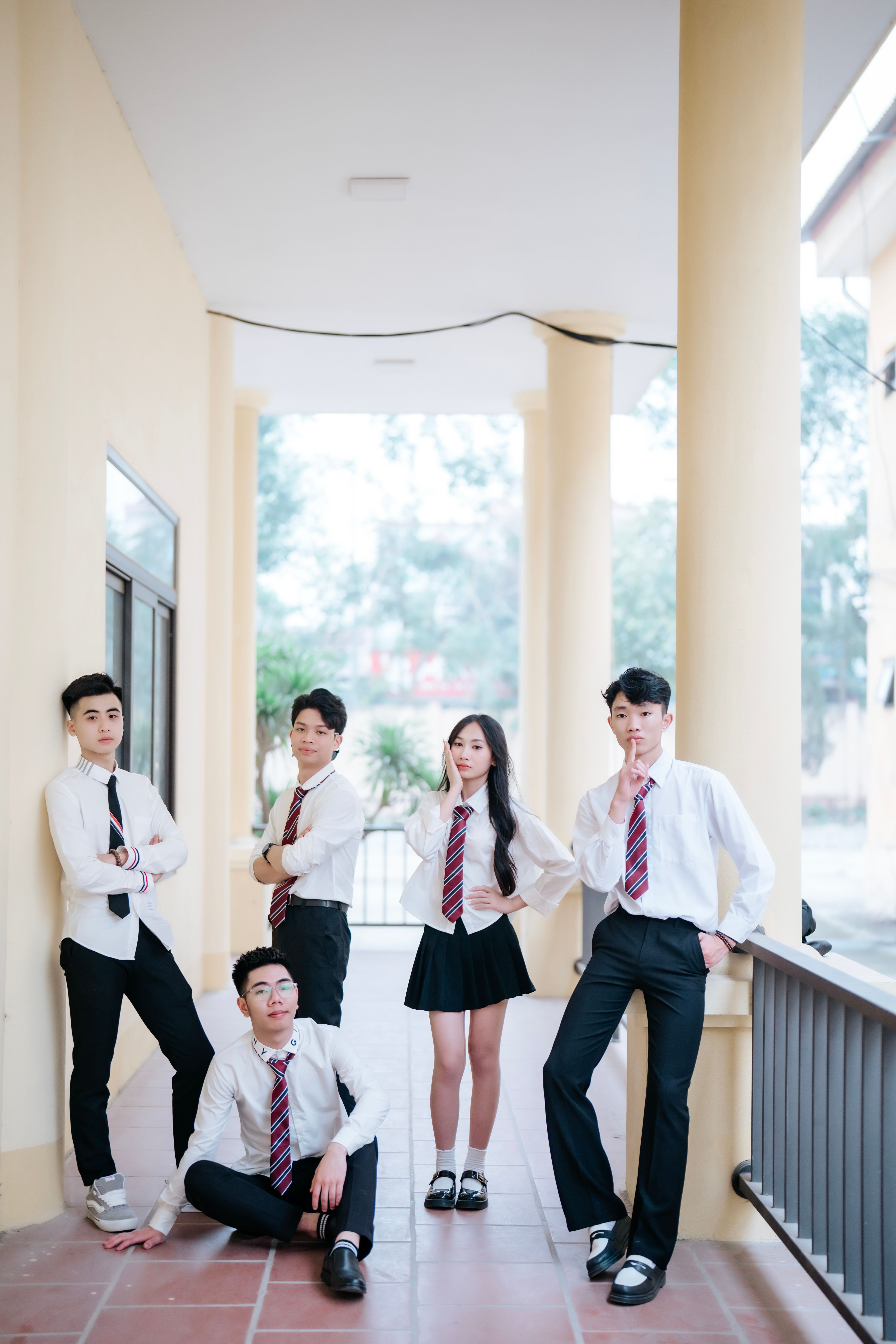 Group of Students in Uniforms Standing in Hallway · Free Stock Photo
