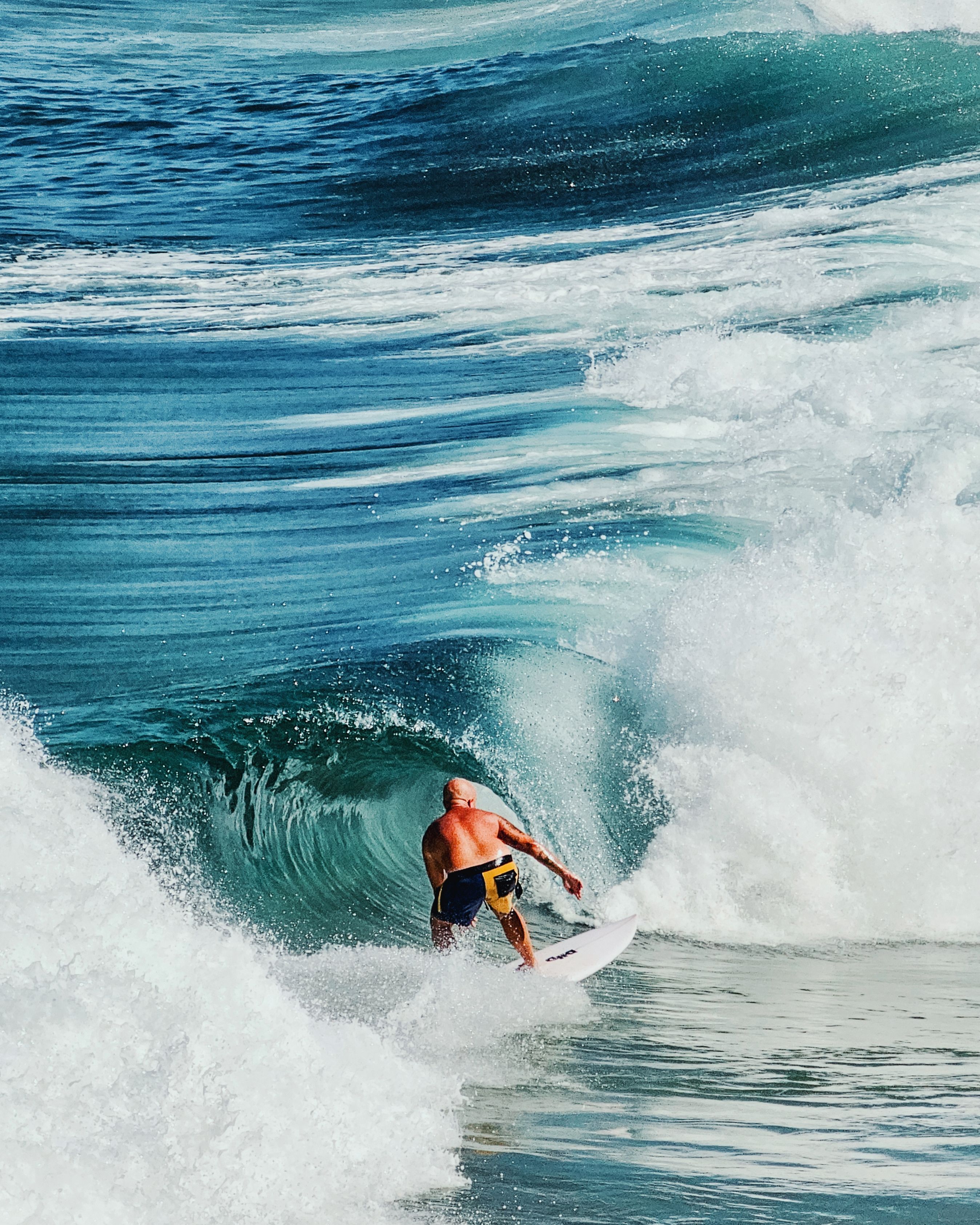 Dynamic Surfing Action on Ocean Waves · Free Stock Photo