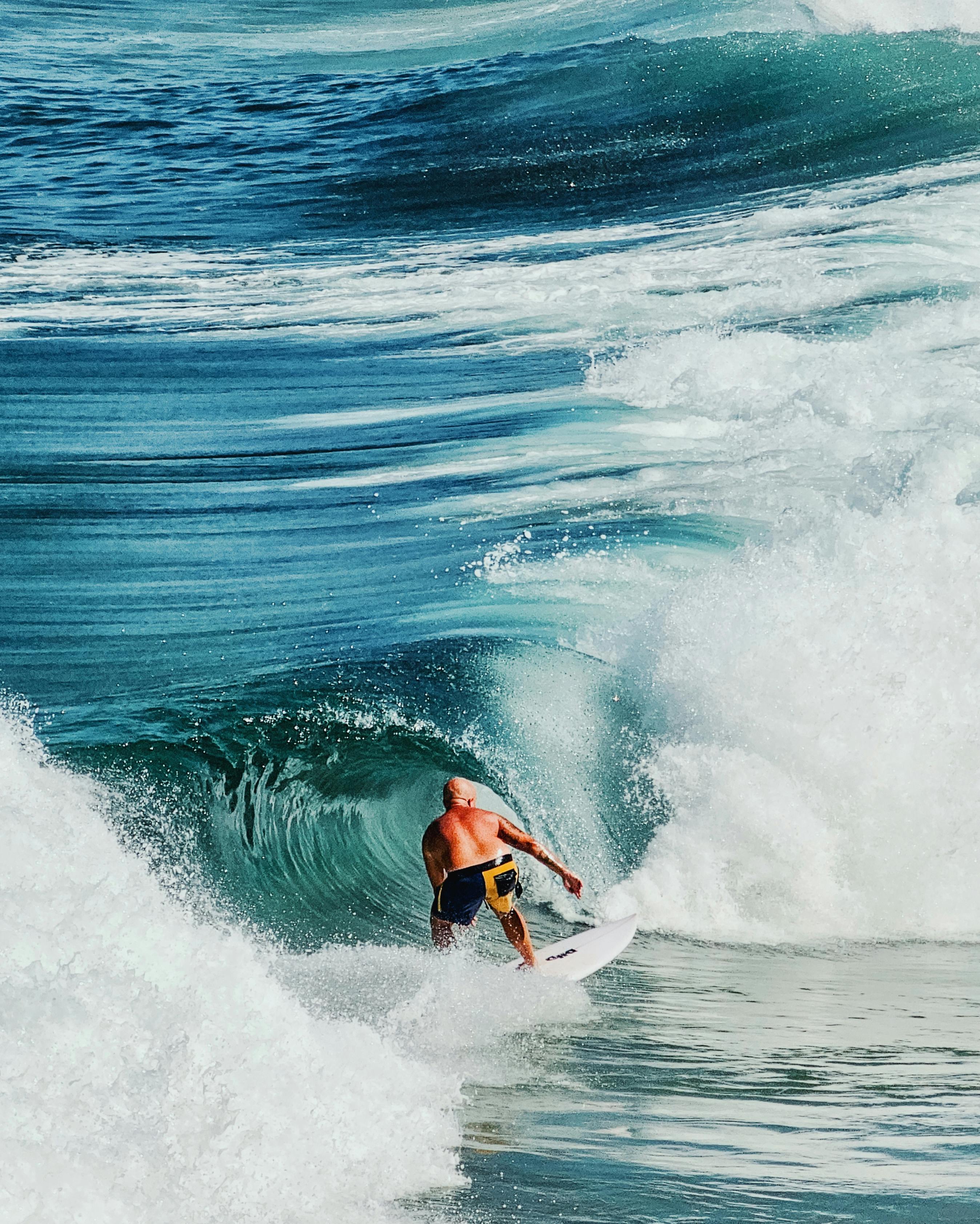 Dynamic Surfing Action on Ocean Waves · Free Stock Photo