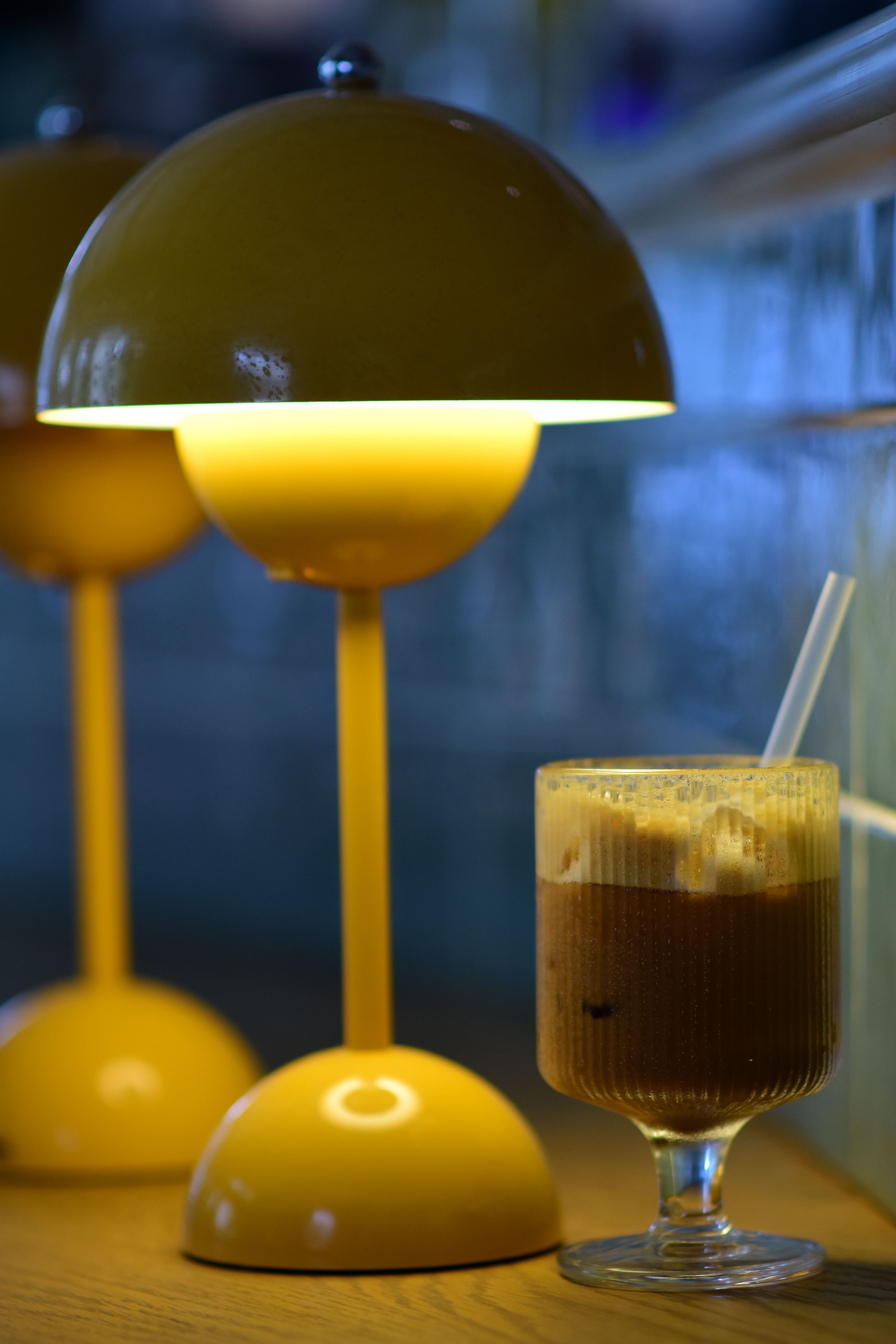 Yellow Lamps and Iced Coffee on Wooden Table · Free Stock Photo
