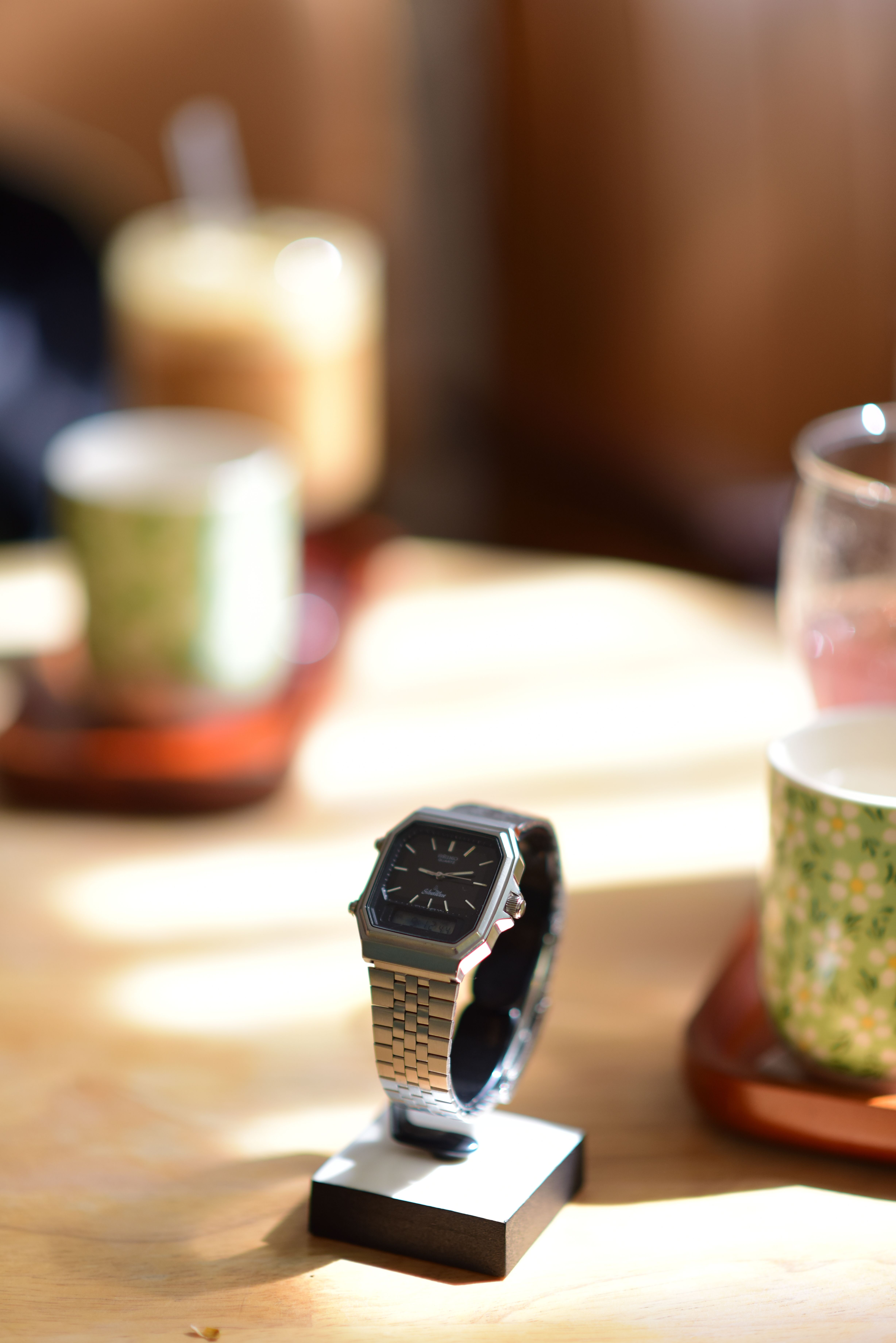 Elegant Metal Watch on Sunlit Café Table · Free Stock Photo