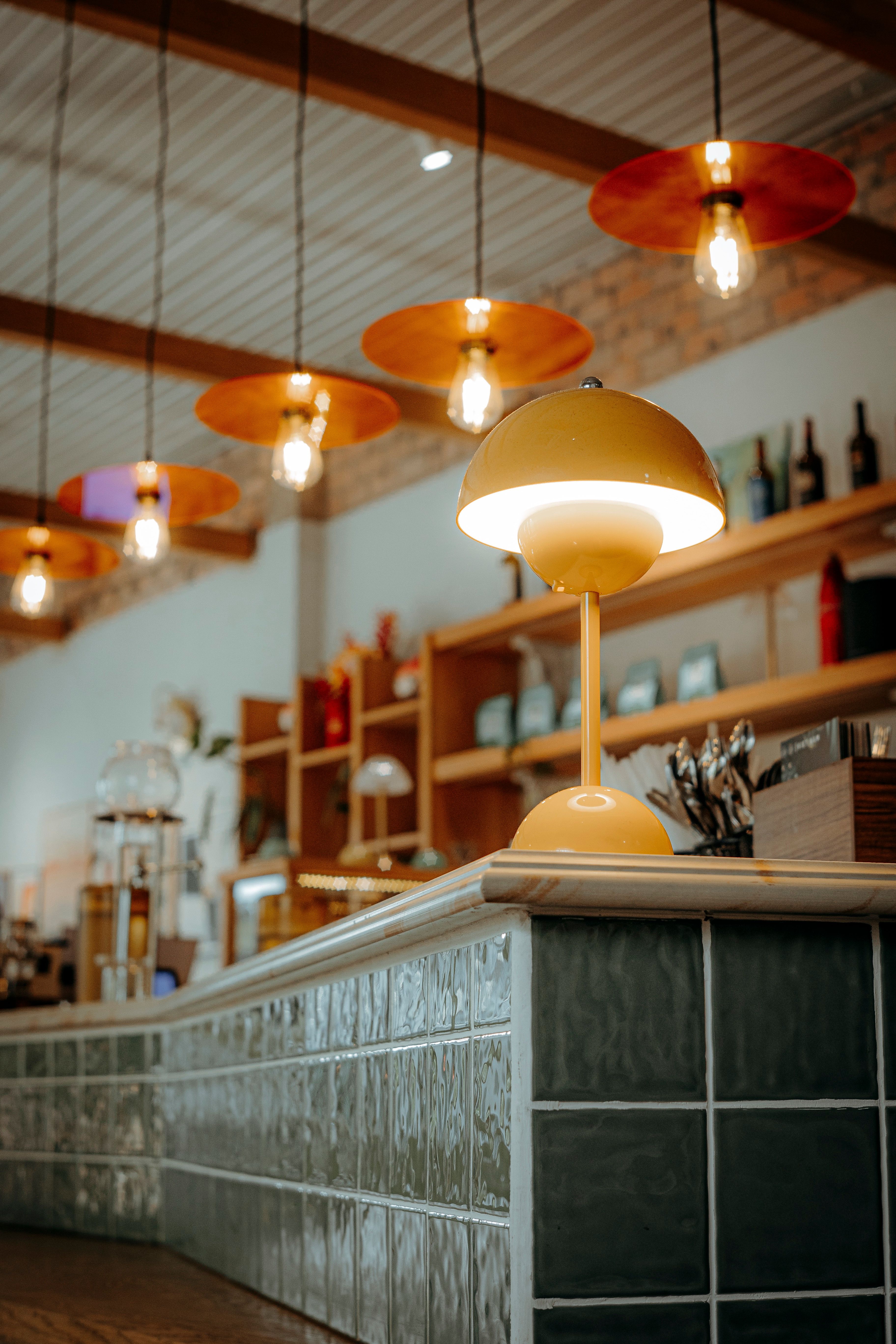 Warm Cafe Interior with Modern Lighting Design · Free Stock Photo