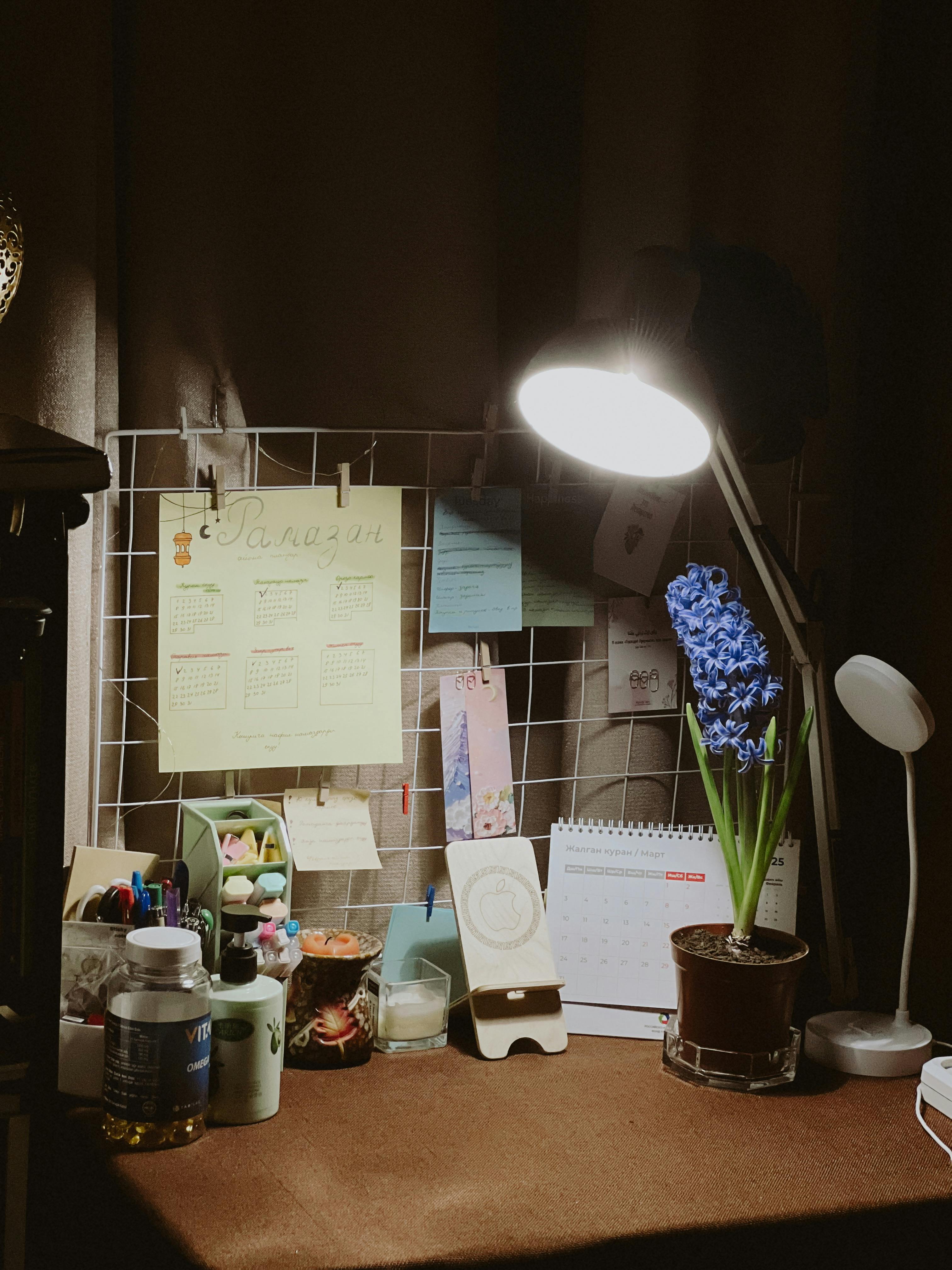 Cozy Desk Setup with Lamp and Blue Flowers · Free Stock Photo