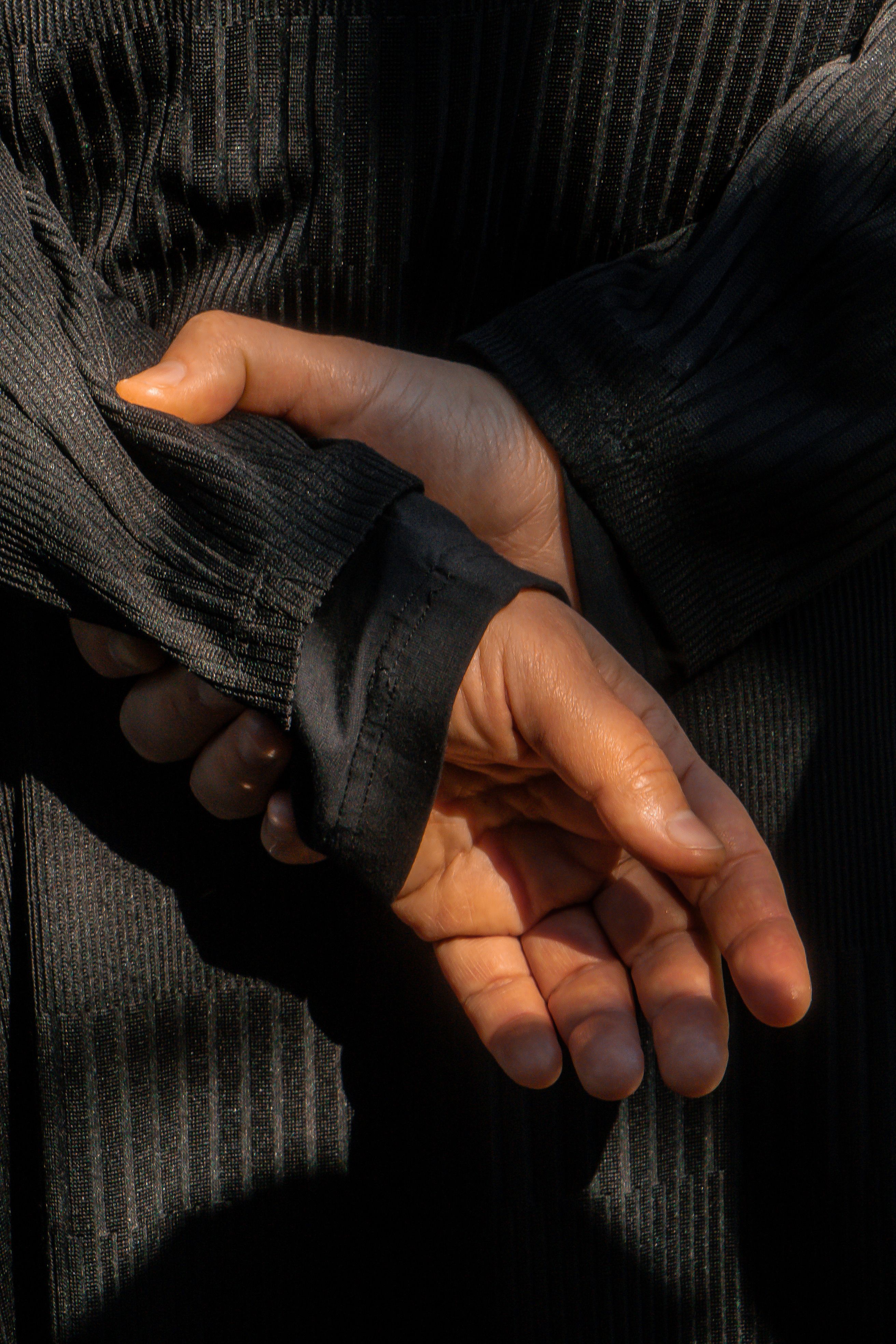 Close-up of Hands Resting Calmly in Shadow · Free Stock Photo