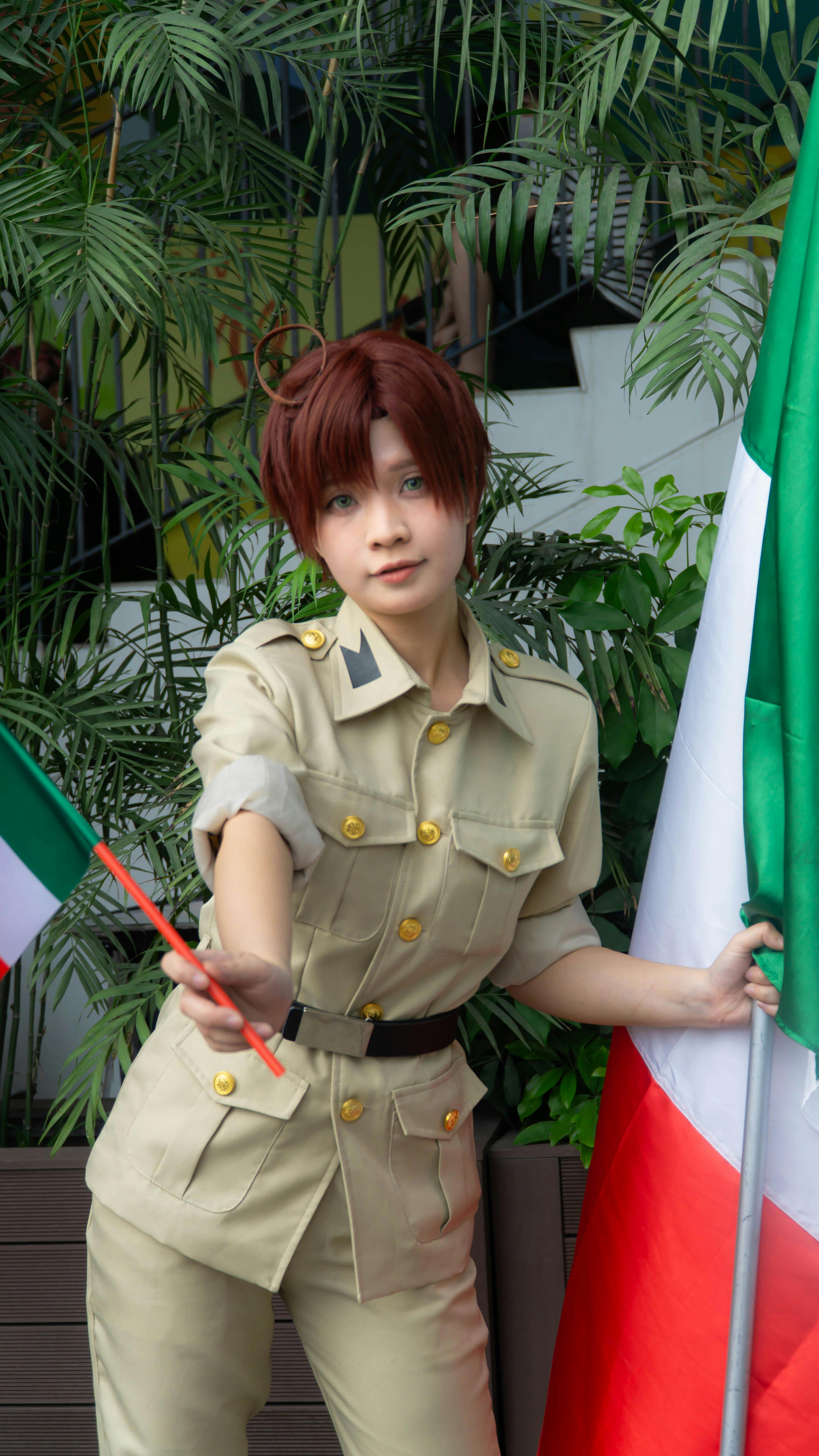 Cosplayer in Military Uniform with Flags Outdoors · Free Stock Photo