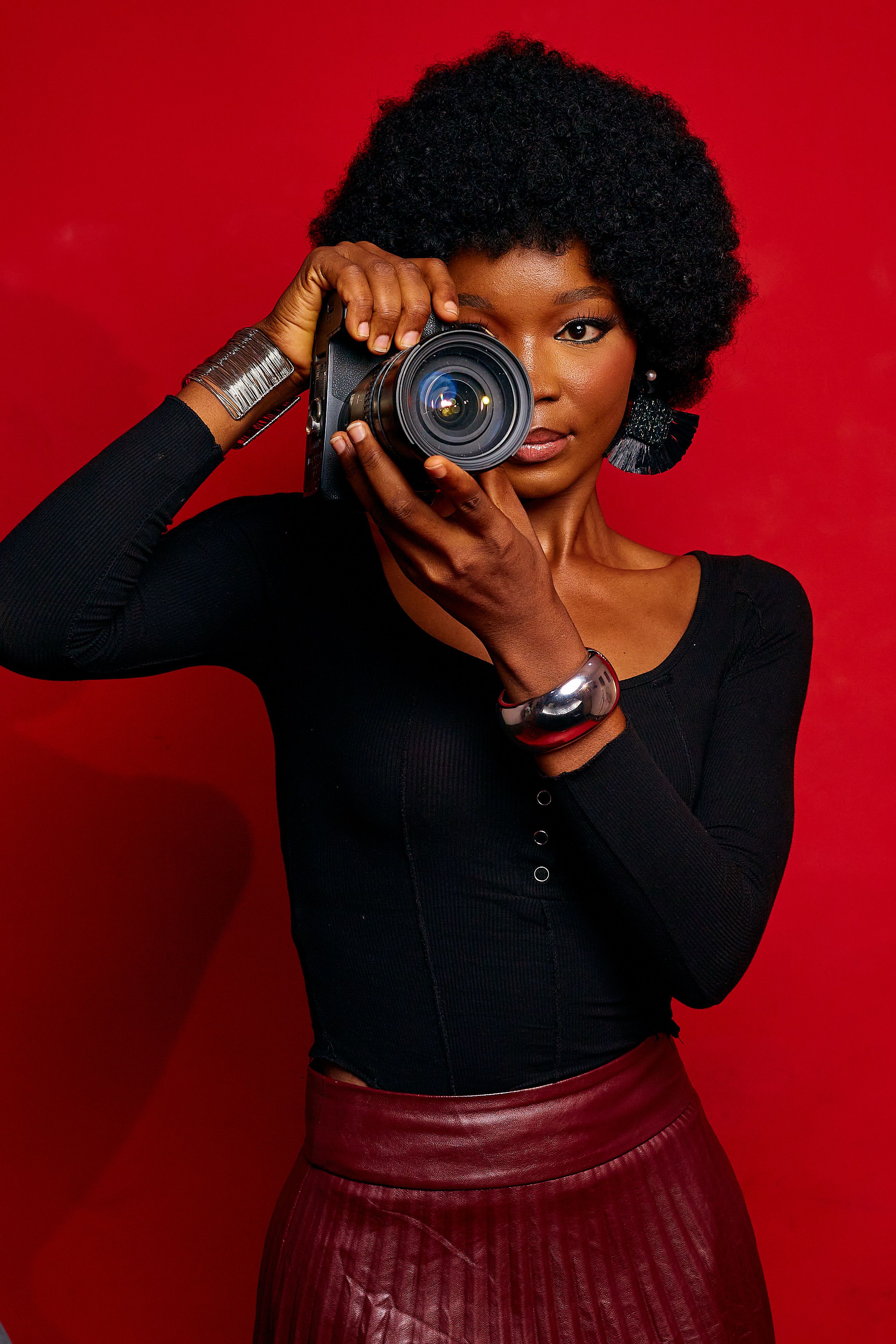 Portrait of Photographer with Camera Against Red · Free Stock Photo