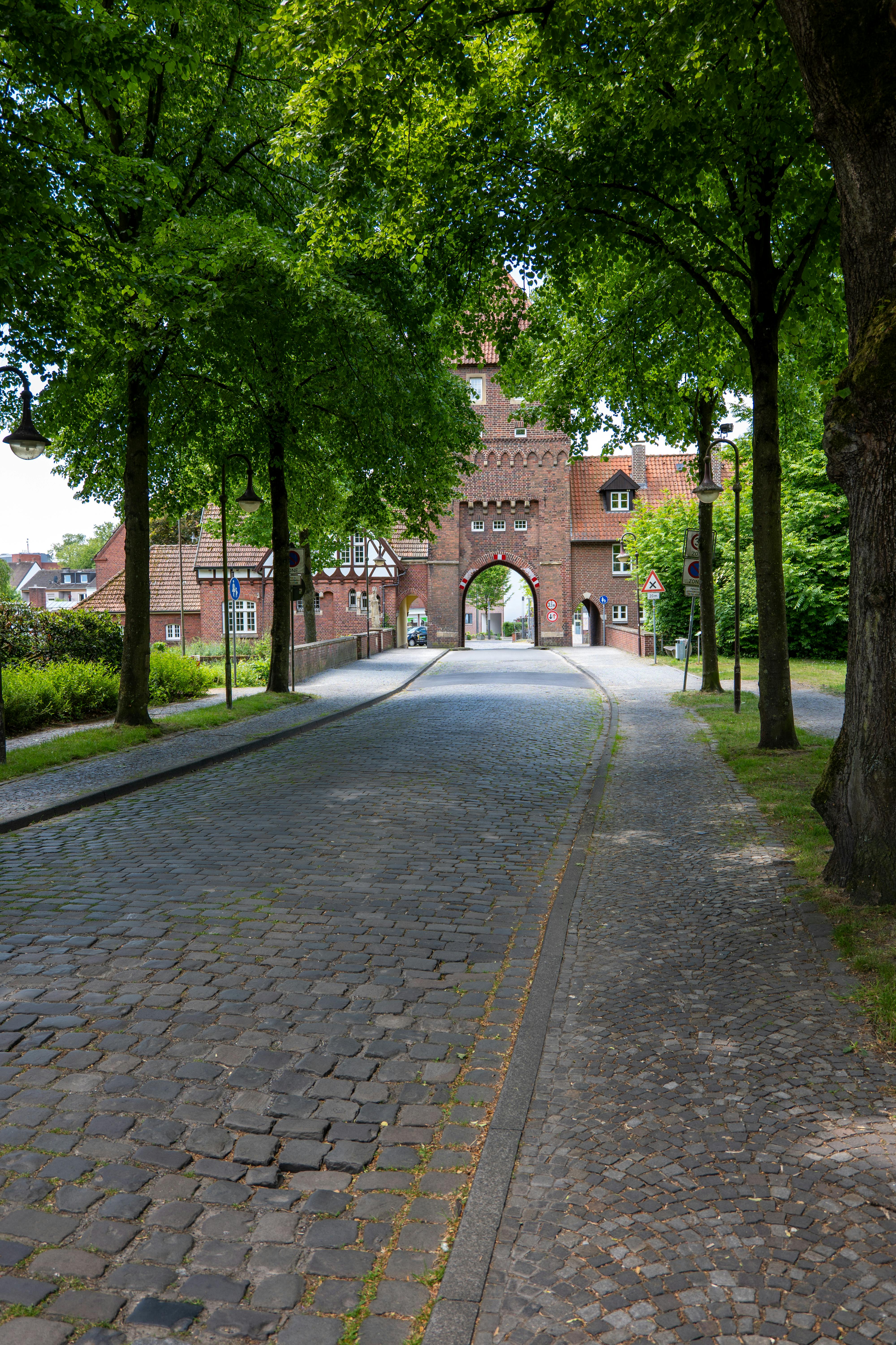 Historic Brick Gateway in Lush Green Setting · Free Stock Photo