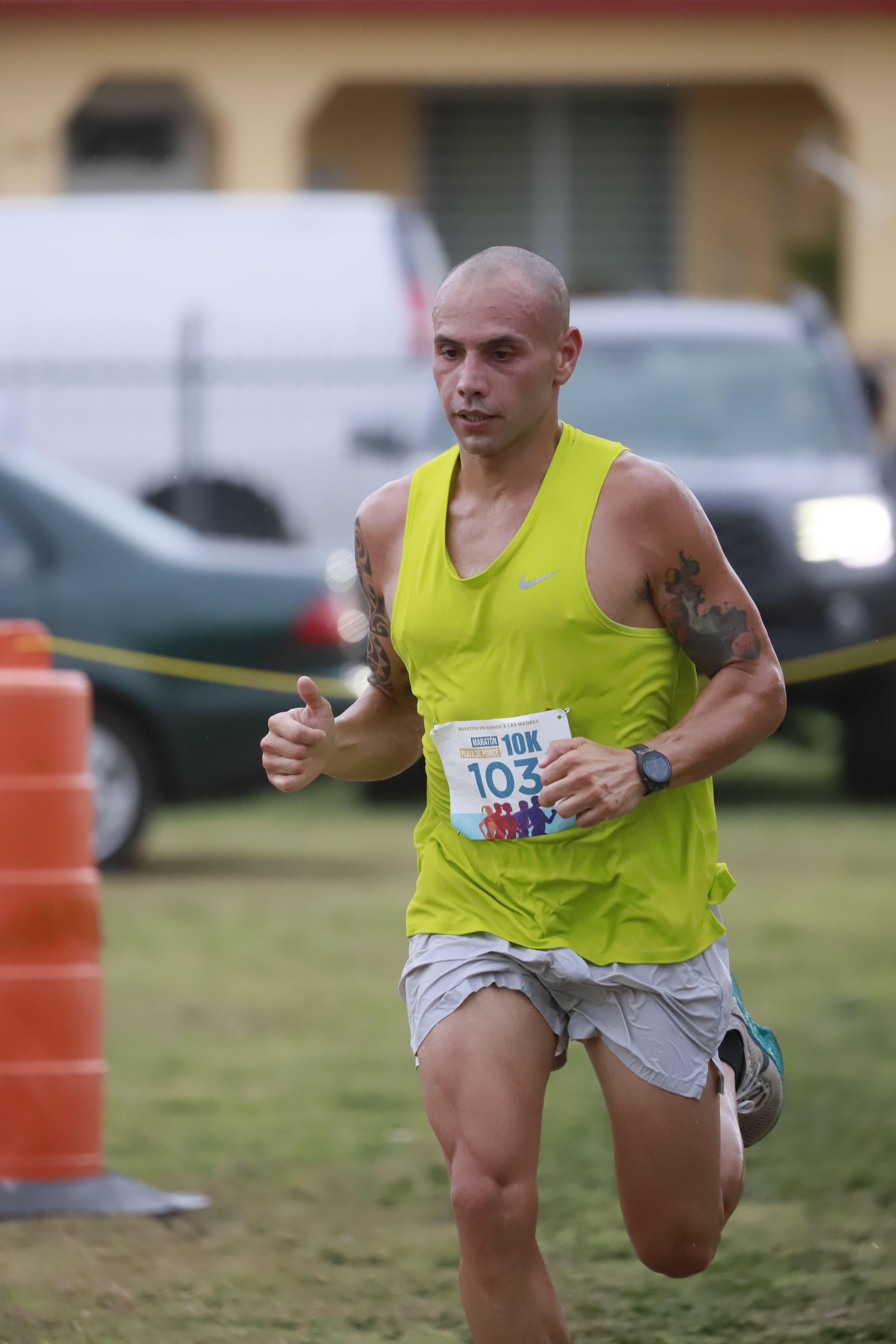 Focused Male Runner Competing in 10K Race Outdoors · Free Stock Photo
