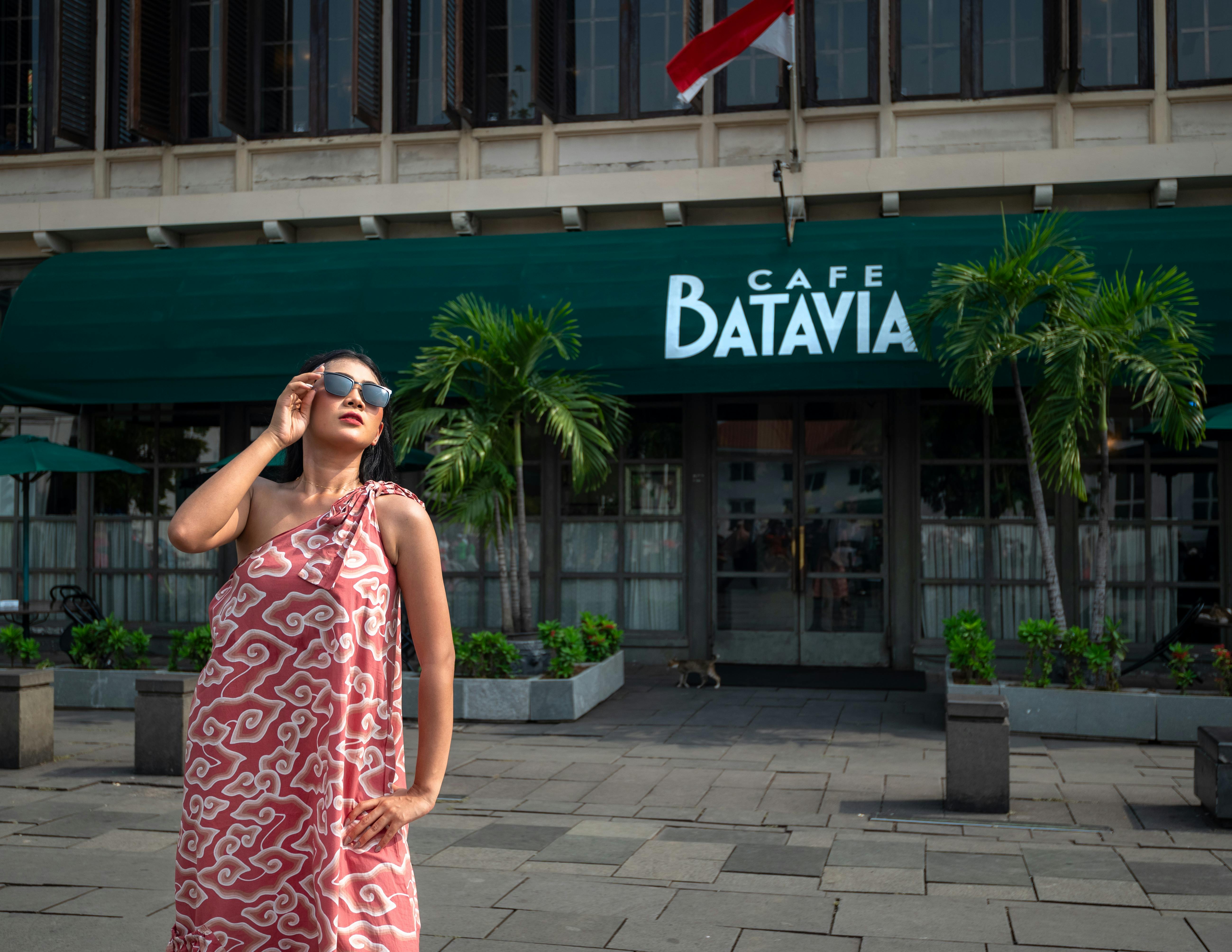 Stylish Woman in Batik Dress at Café Batavia · Free Stock Photo
