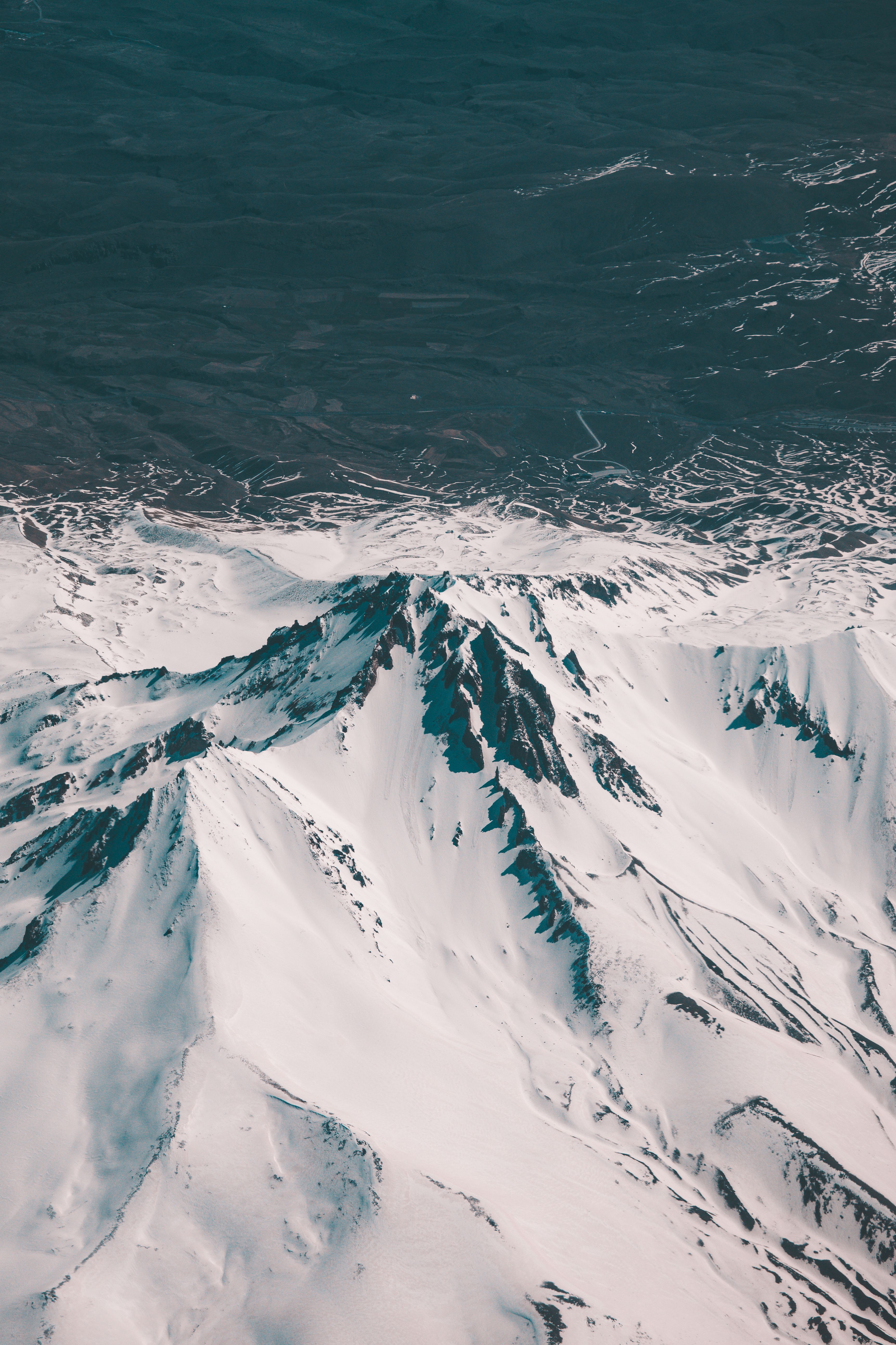 Aerial View of Snow-Covered Mountain Peaks · Free Stock Photo