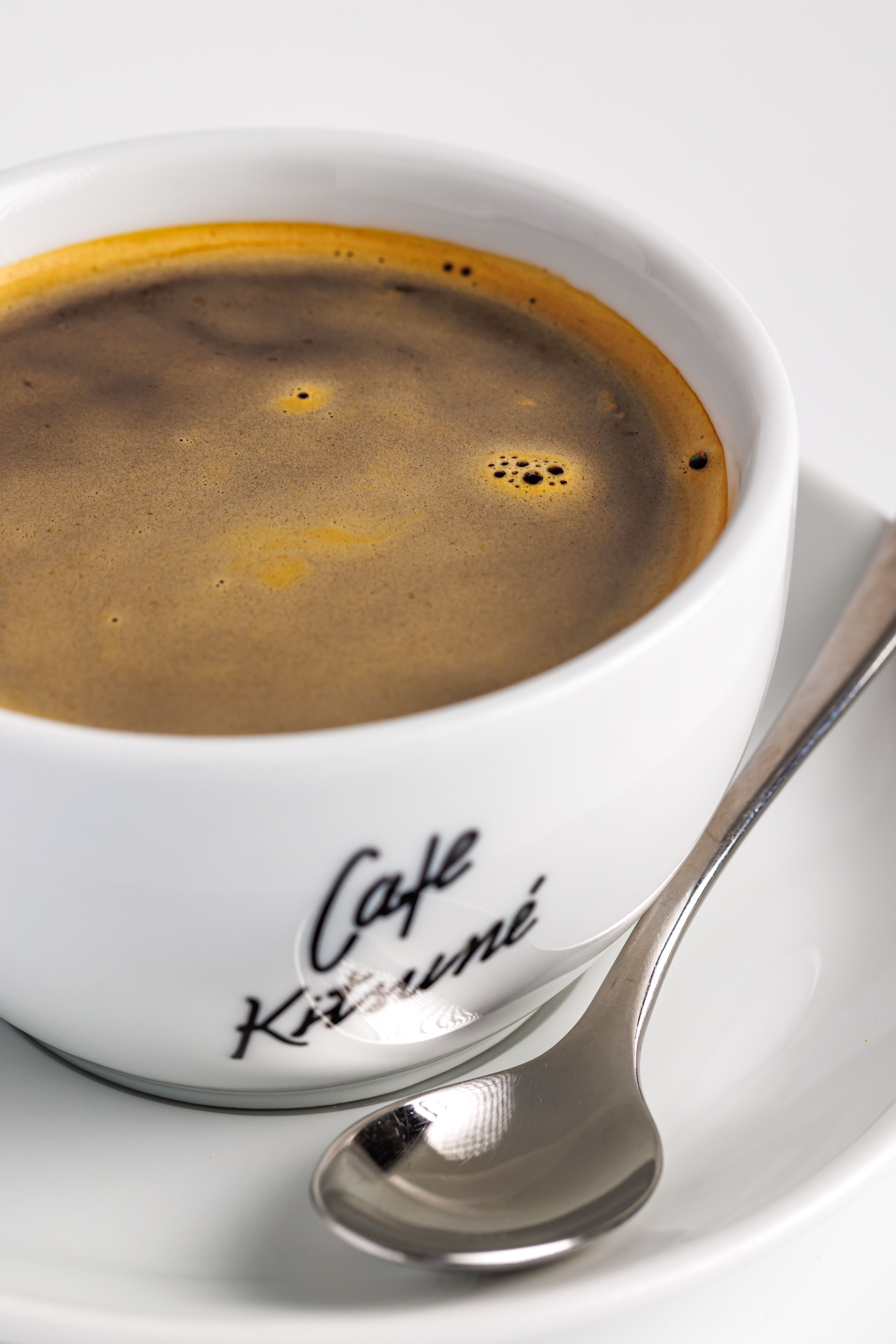 Close-up of a Coffee Cup with Cafe Logo · Free Stock Photo