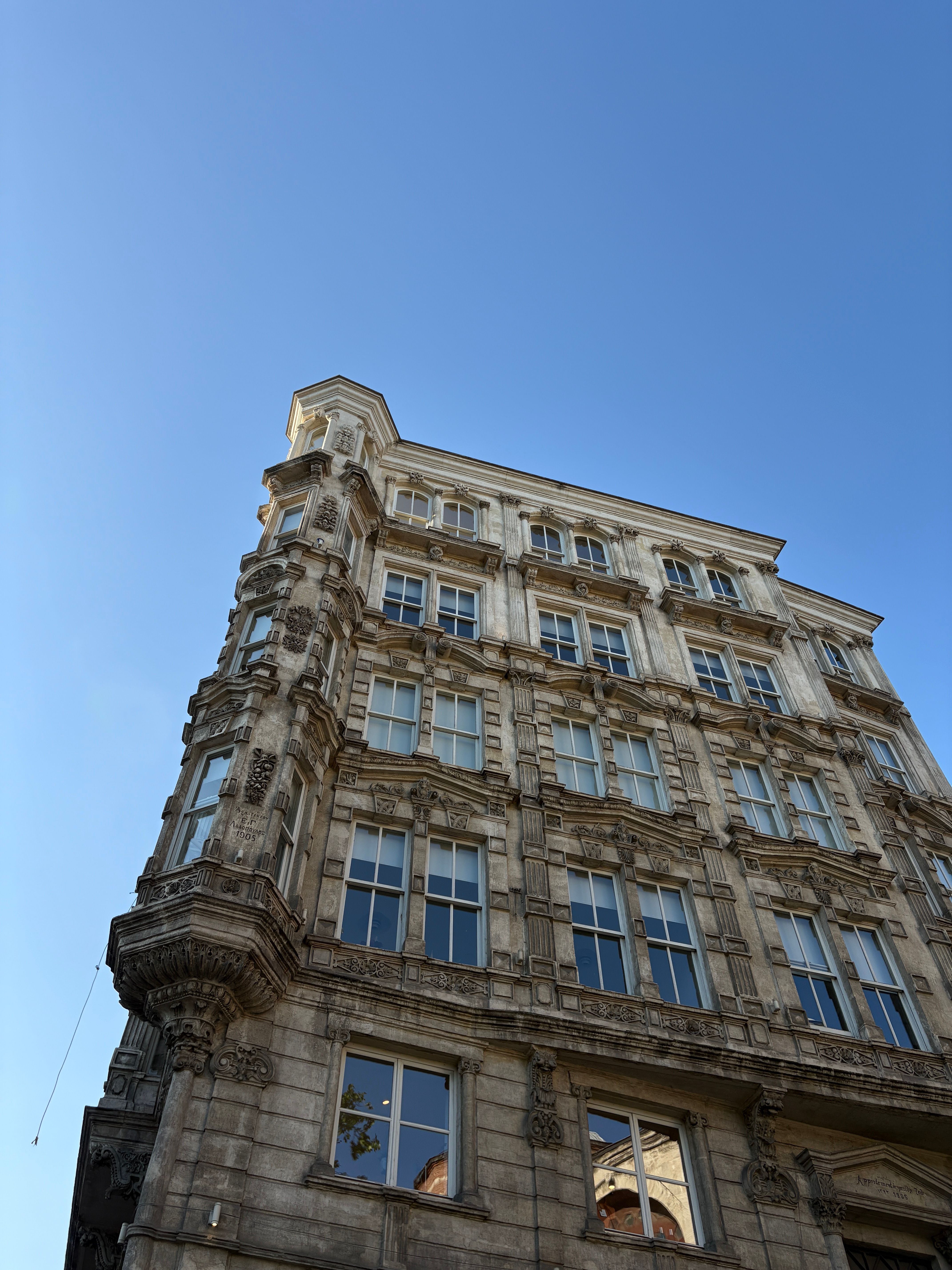 Historic Stone Building Against Clear Blue Sky · Free Stock Photo