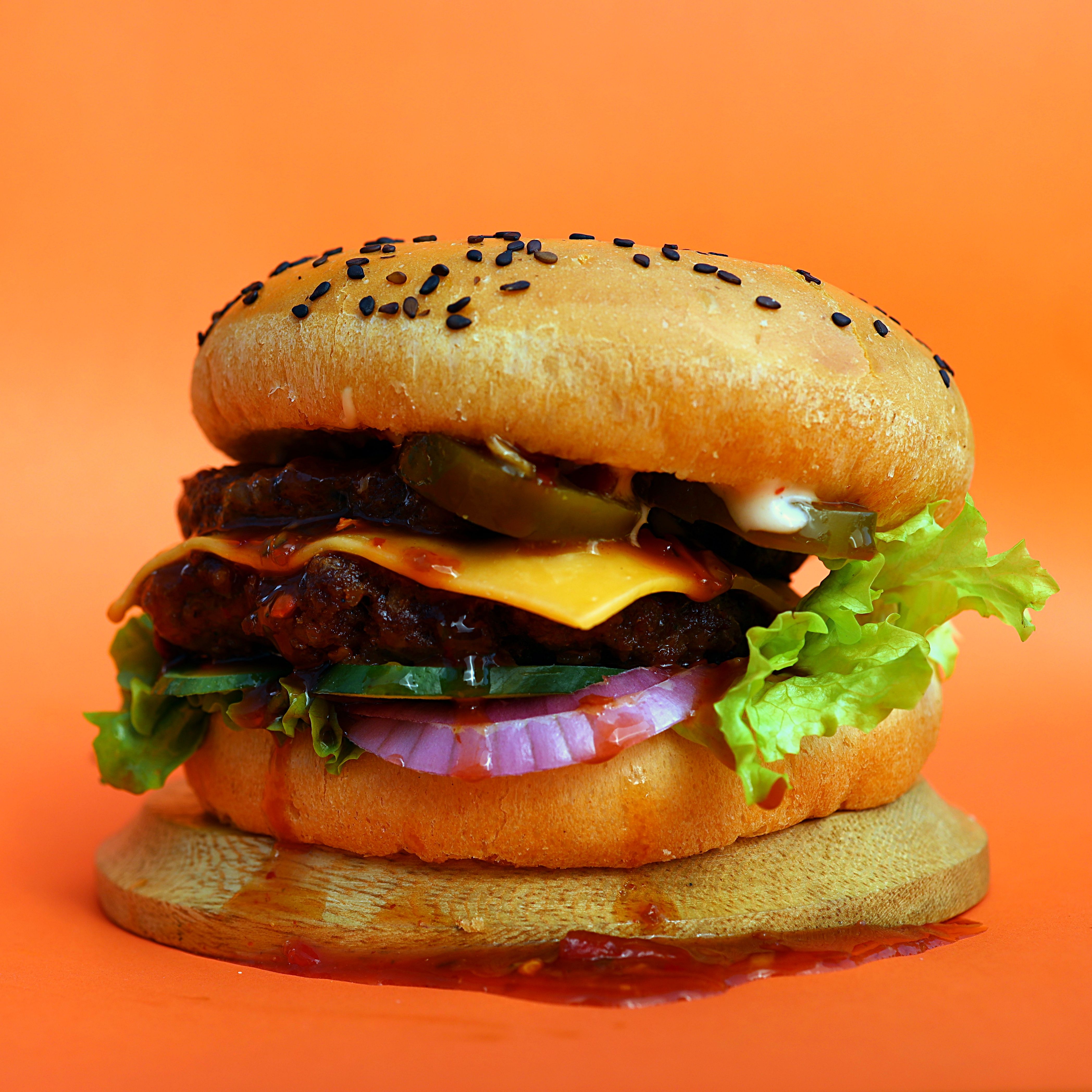 Delicious Spicy Double Cheeseburger on Orange Background · Free Stock Photo