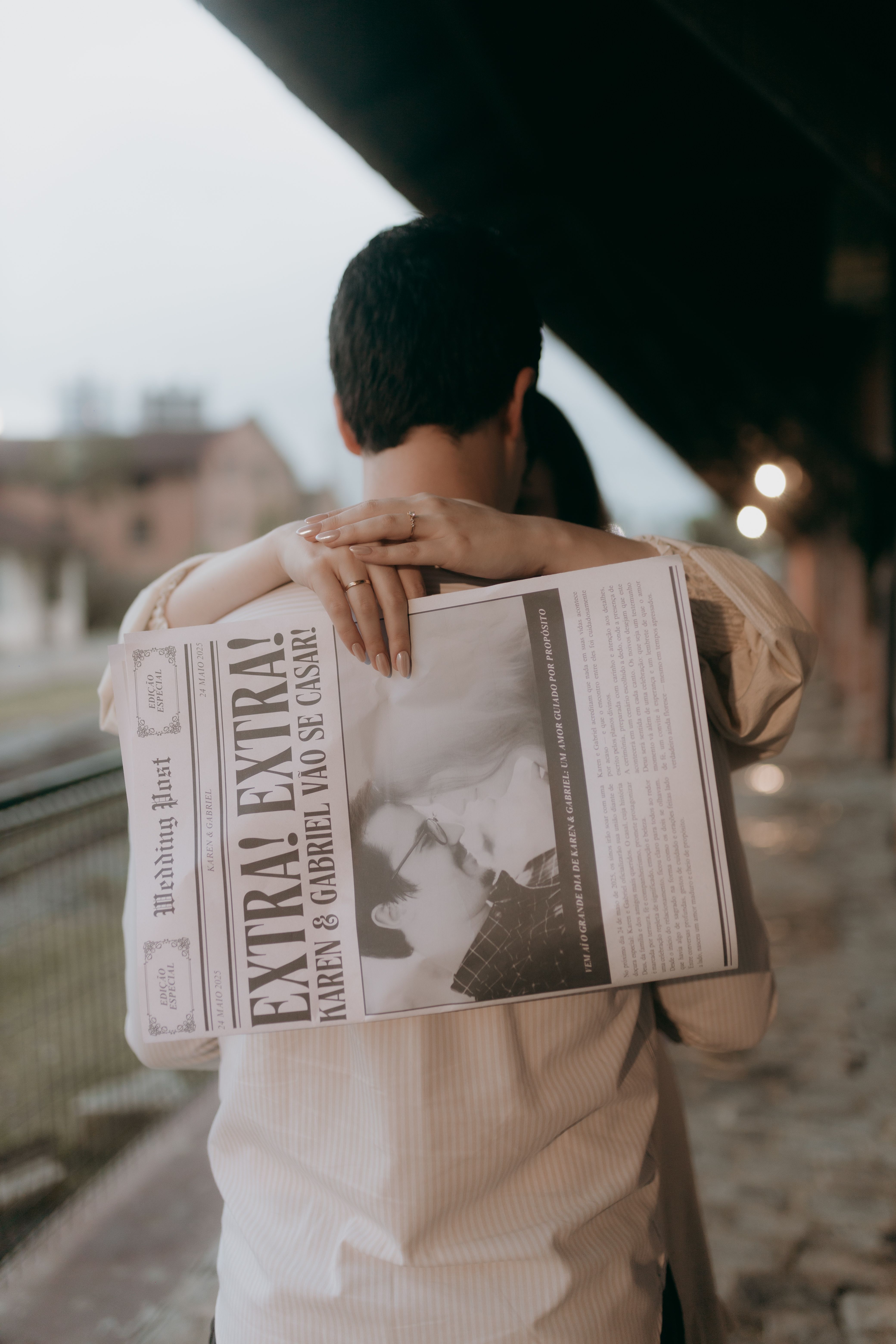 Romantic couple embracing with newspaper announcement · Free Stock Photo