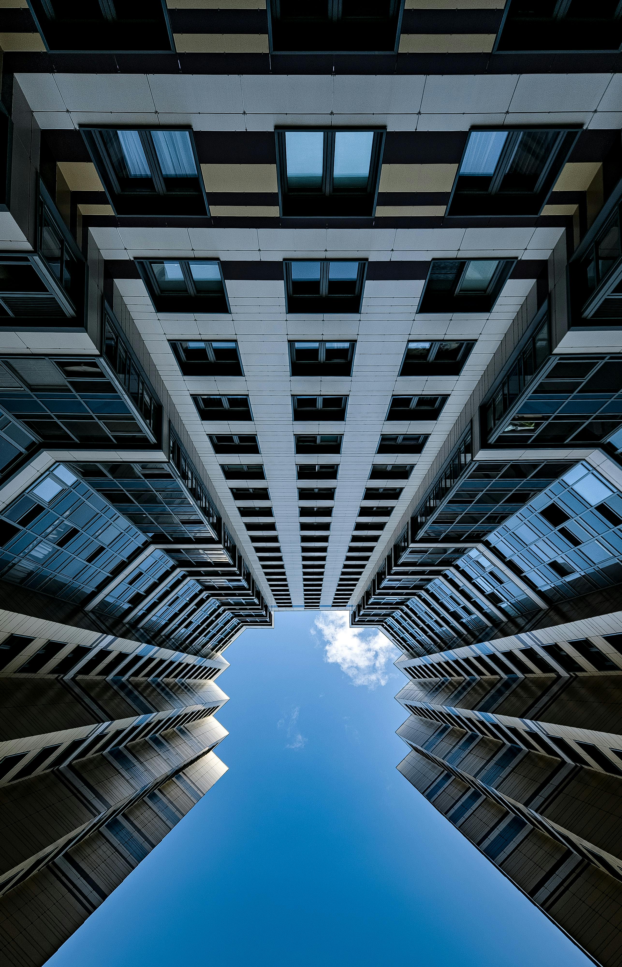 Symmetrical High-Rise Buildings Against Blue Sky · Free Stock Photo