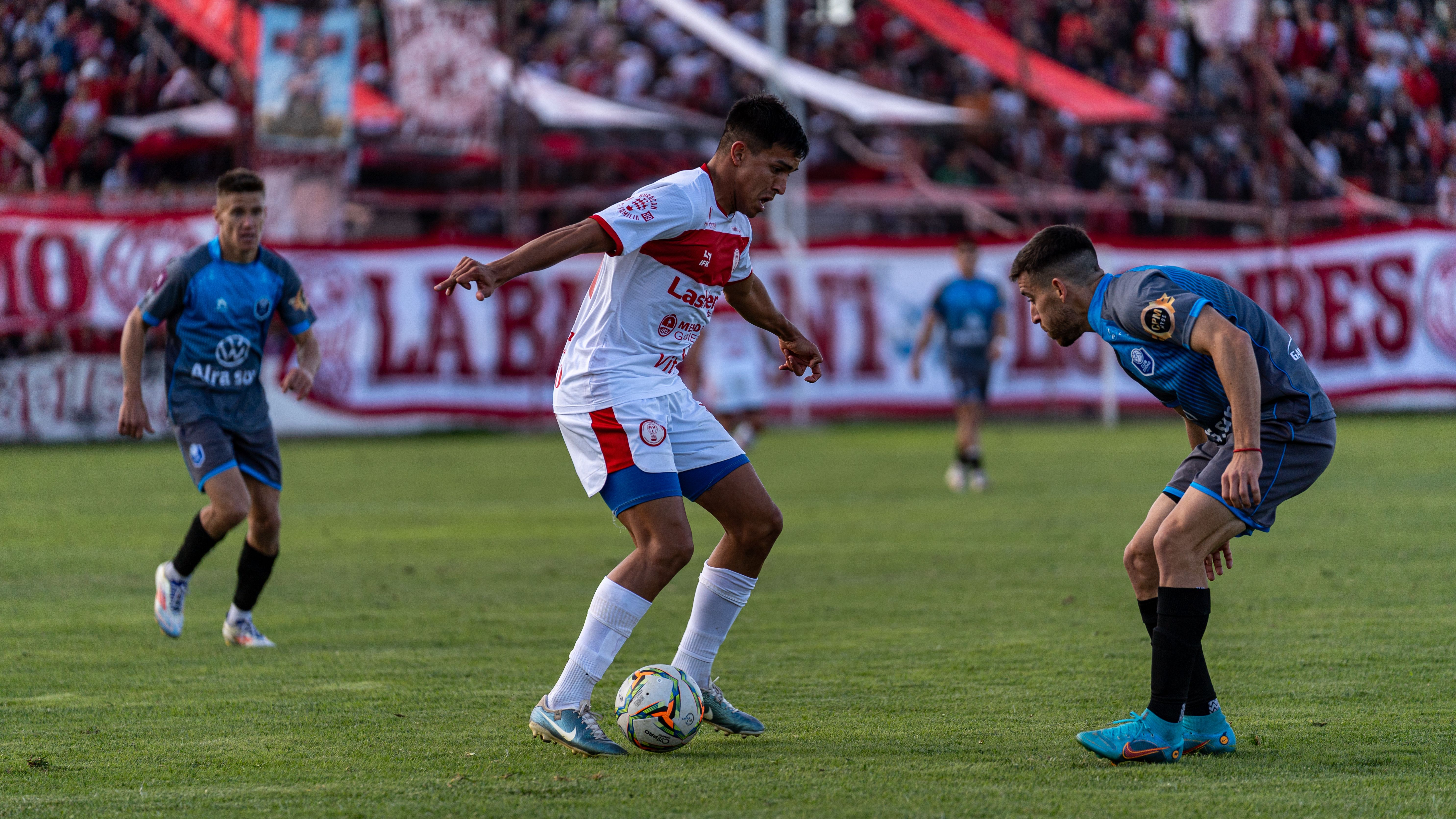 Intense Football Match with Focused Players · Free Stock Photo