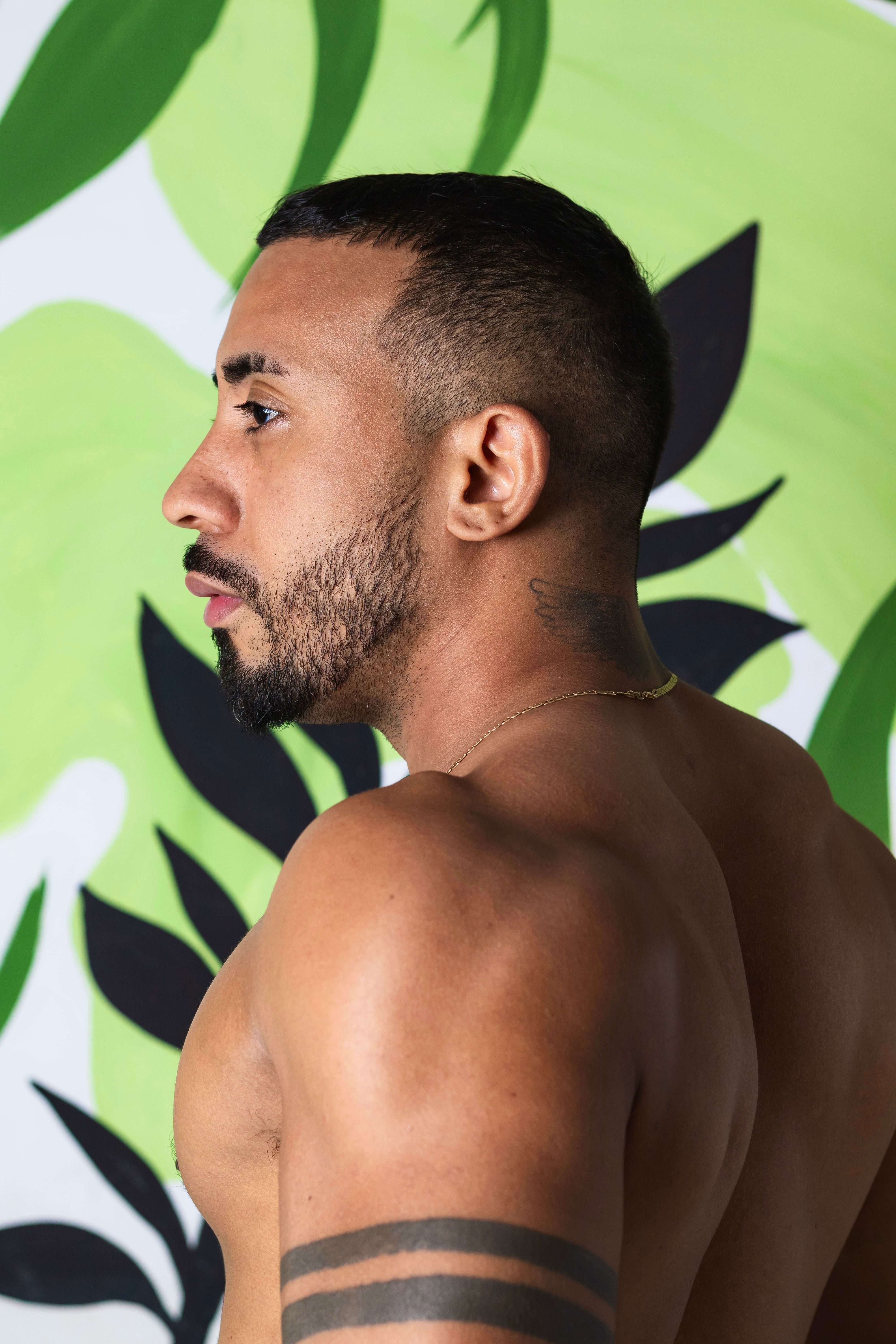 Profile Portrait of a Tattooed Man with Green Leaf Background · Free ...