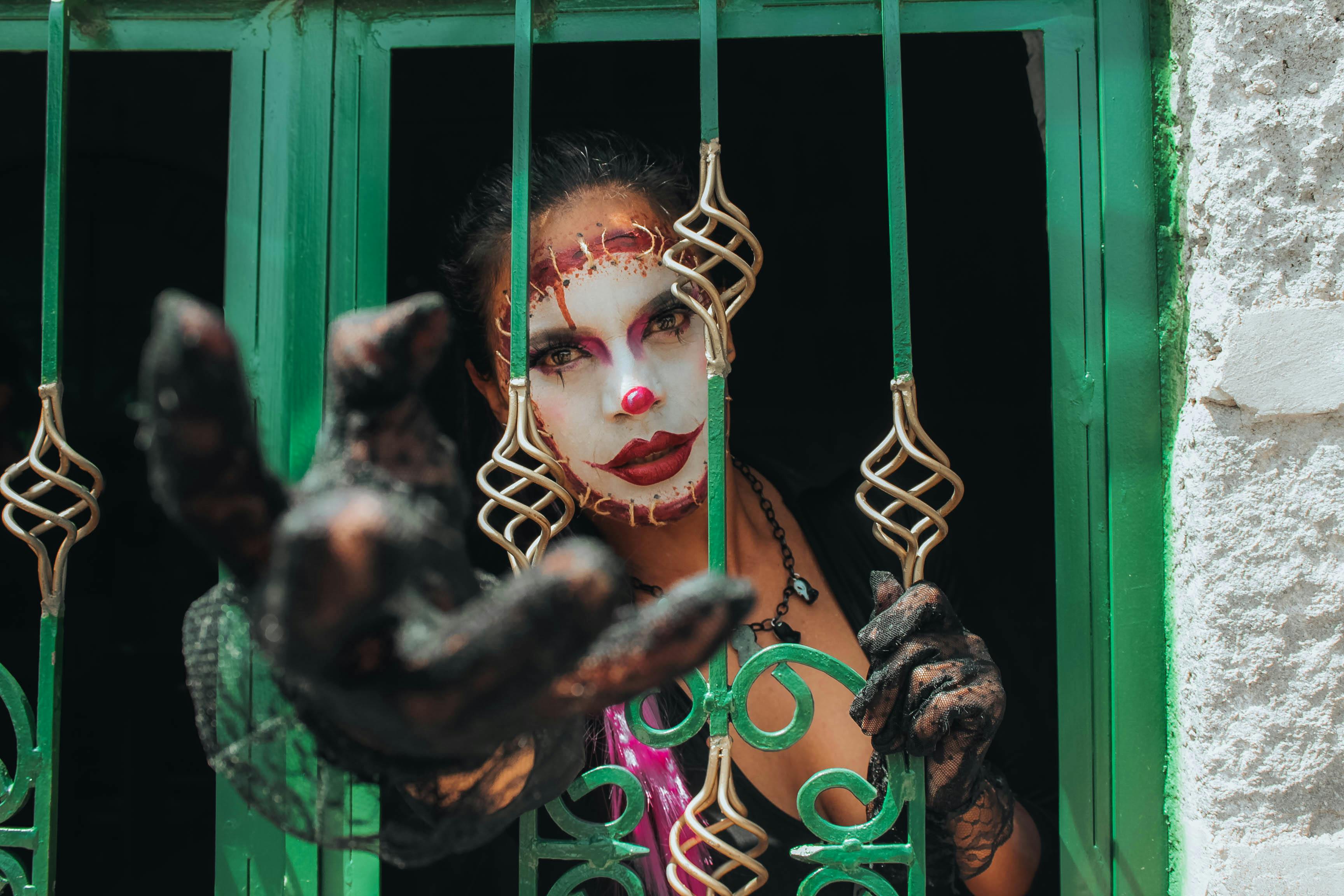 Dramatic Halloween Clown at Window · Free Stock Photo